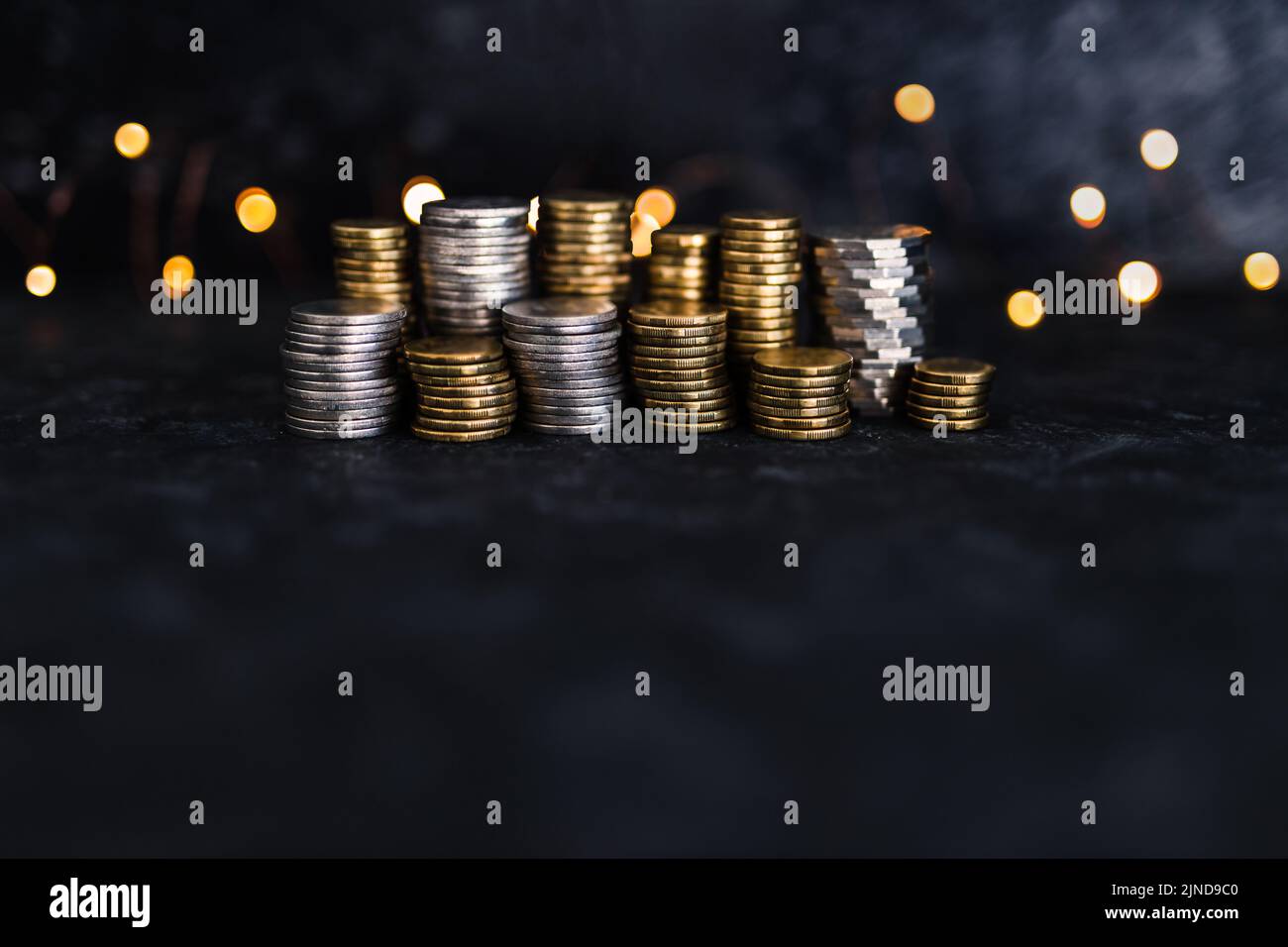 stacks of golden and silver coins creating a big amount of savings shot ...