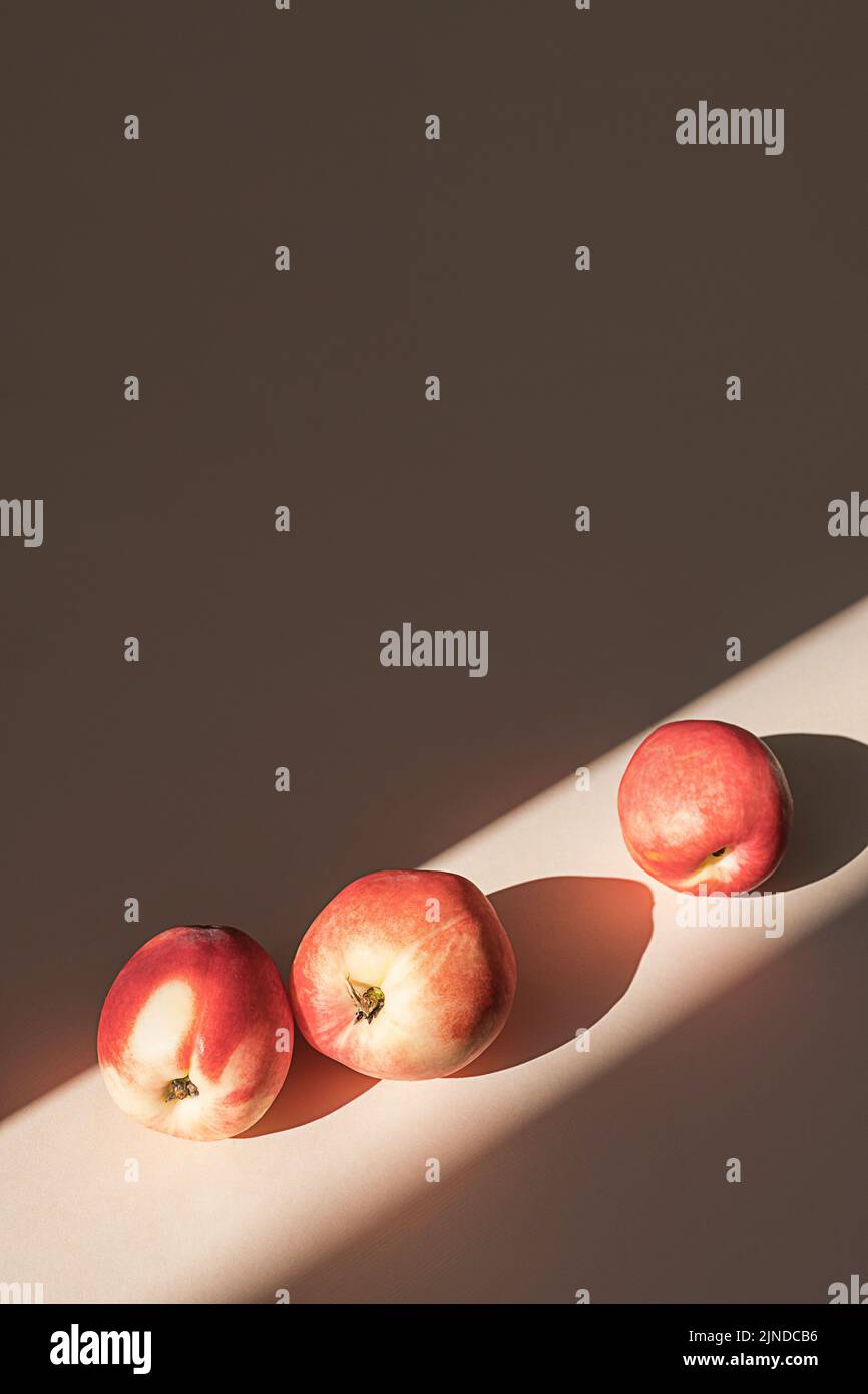 Peaches in sunlight. Minimalism, trendy still life with shadow Stock ...