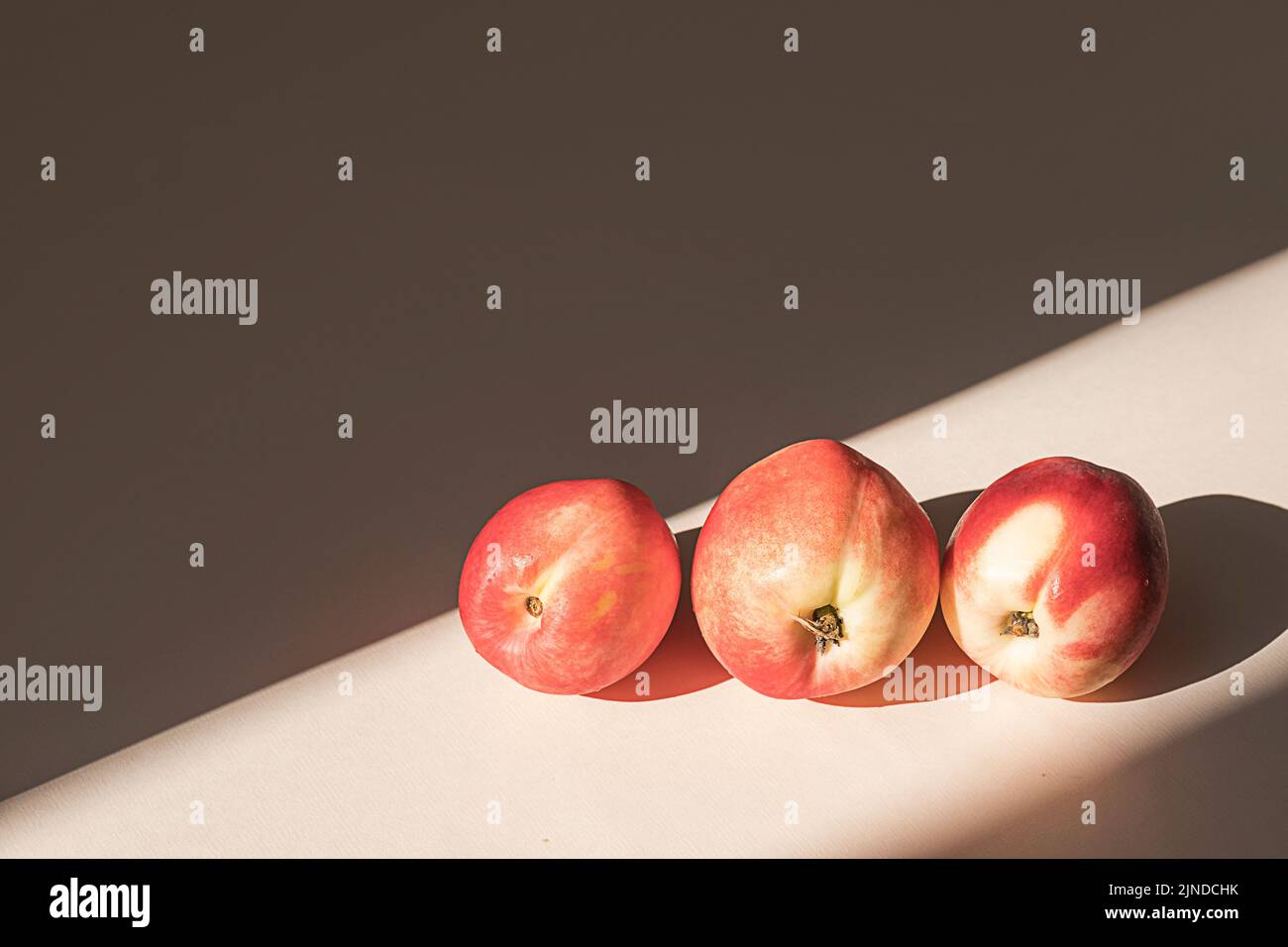 Peaches in sunlight. Minimalism, trendy still life with shadow Stock ...