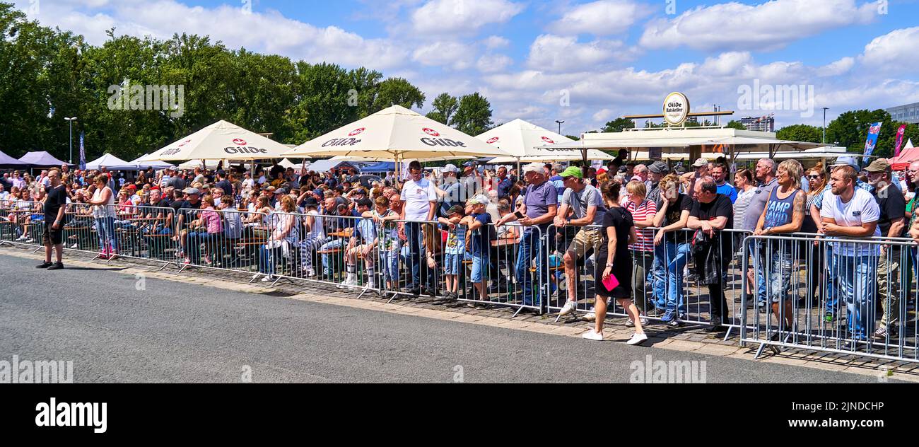 Hannover, Germany, July 23, 2022: Spectators at a car show stand and ...
