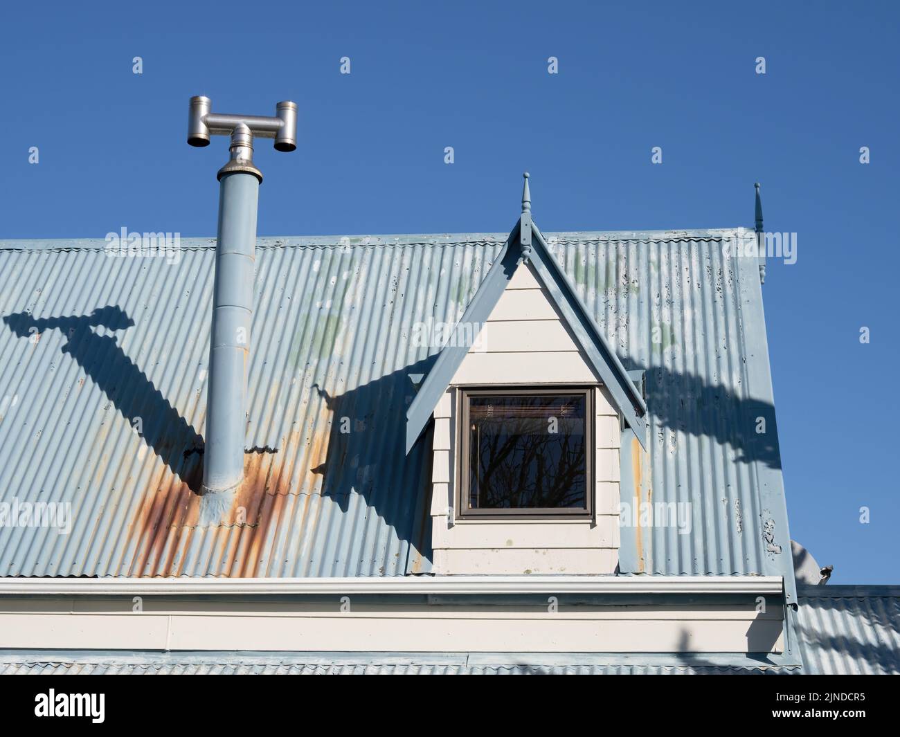 Pitched corrugated steel roof. Chimney with H top stainless steel cowl ...