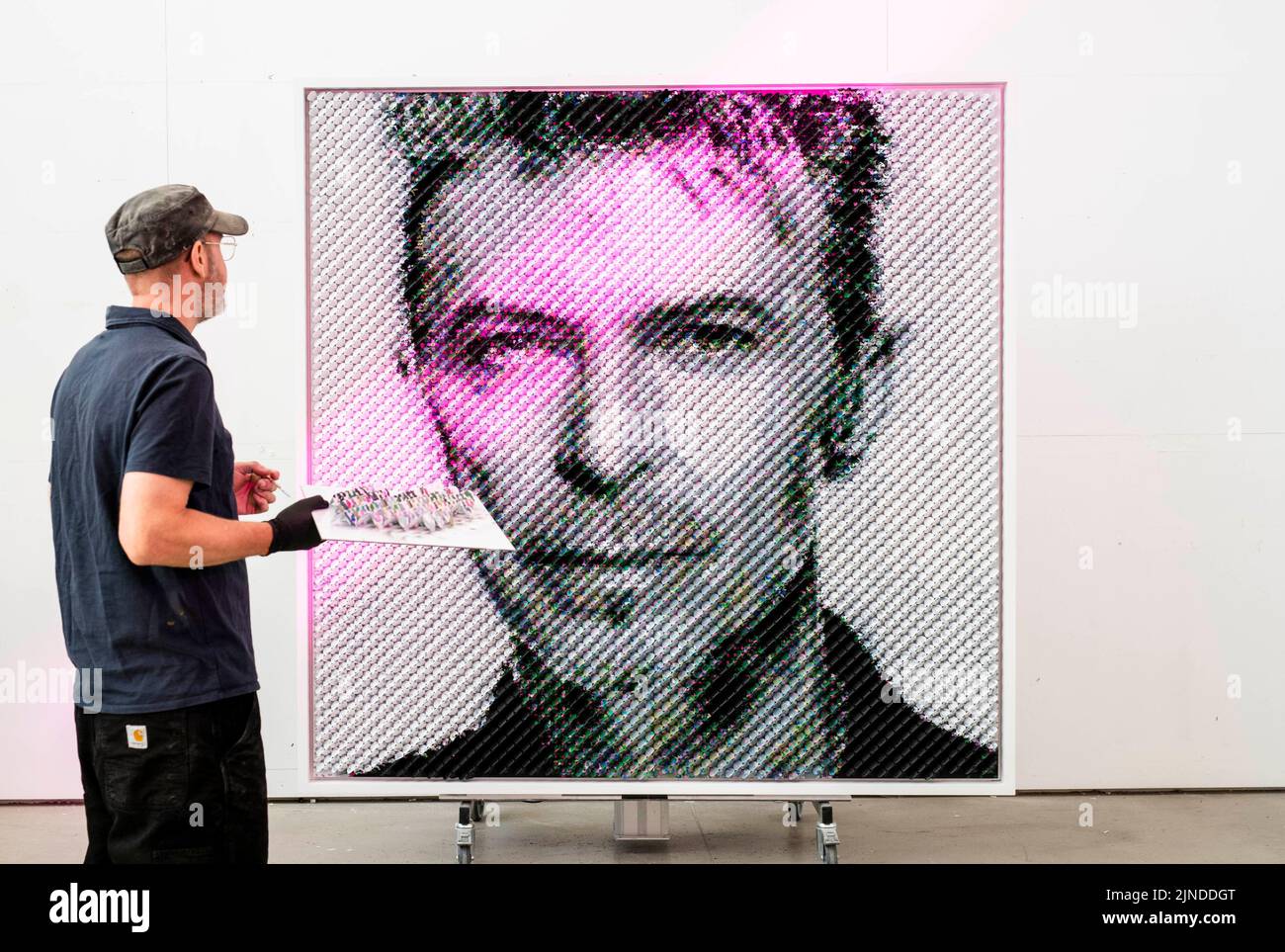 EDITORIAL USE ONLY Artist Joe Black adds the finishing touches to a ...
