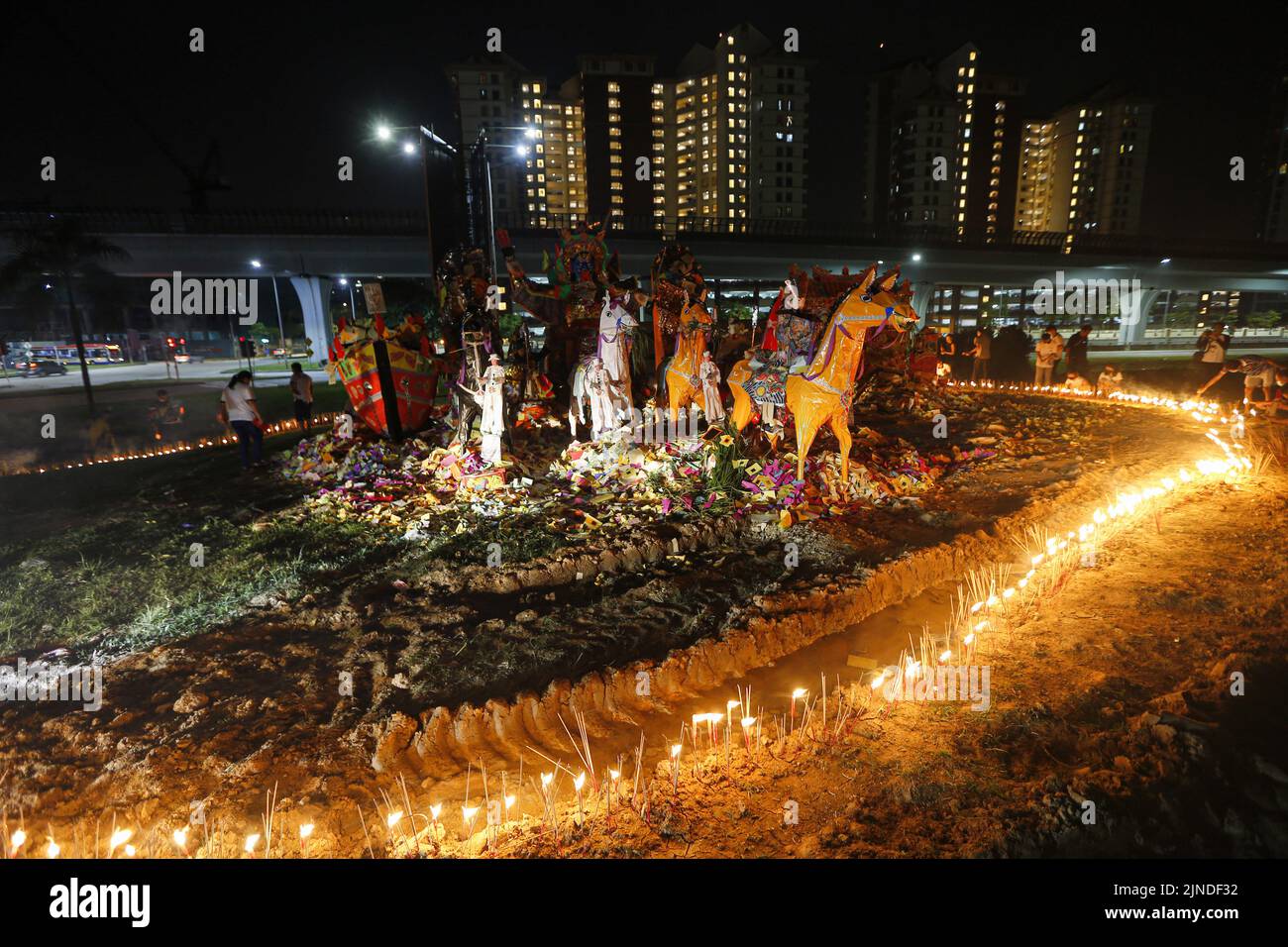 Offerings are surrounded by candles and joss sticks during the Hungry ...