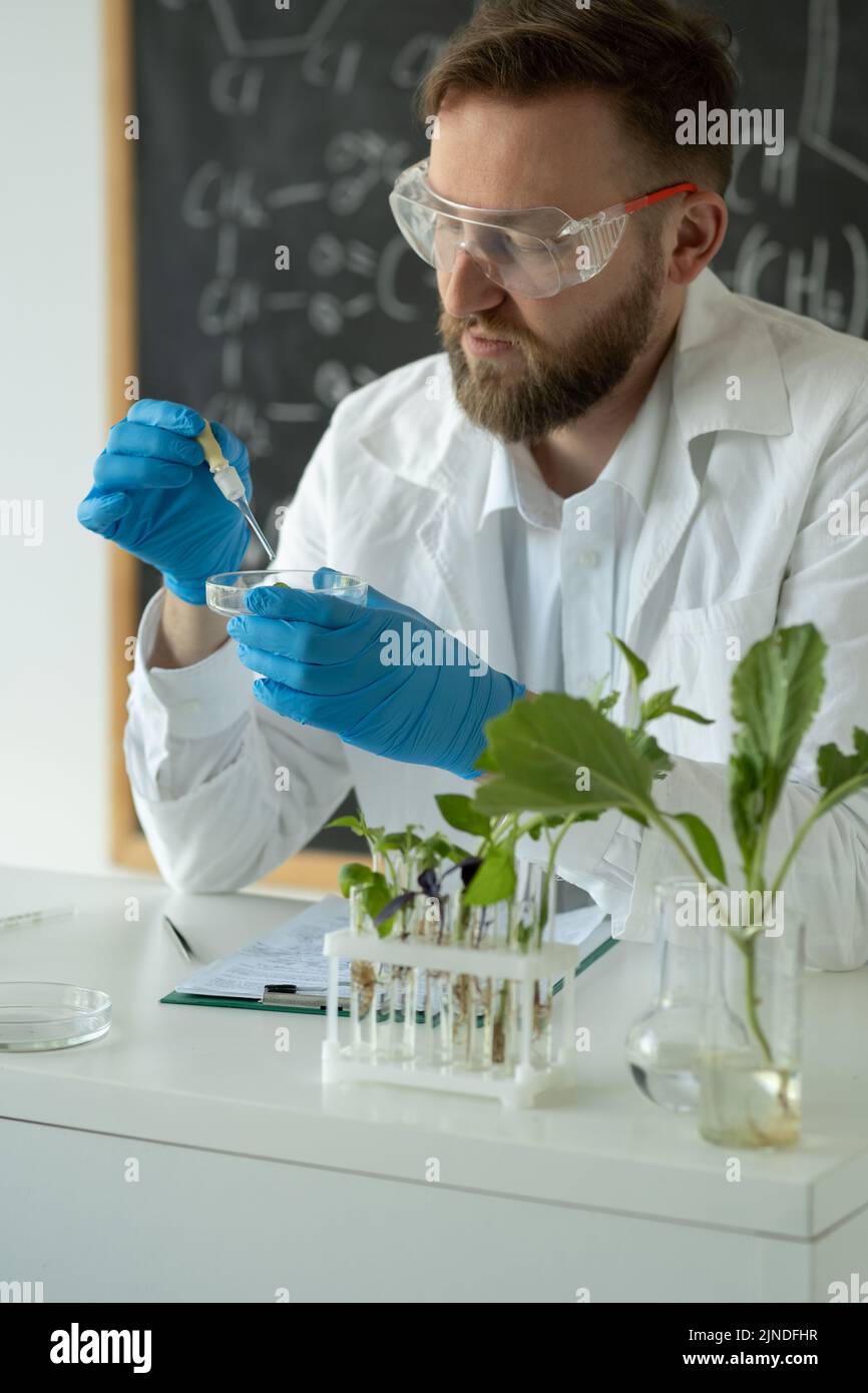 In a school laboratory biologist conducts experiments by synthesizing ...