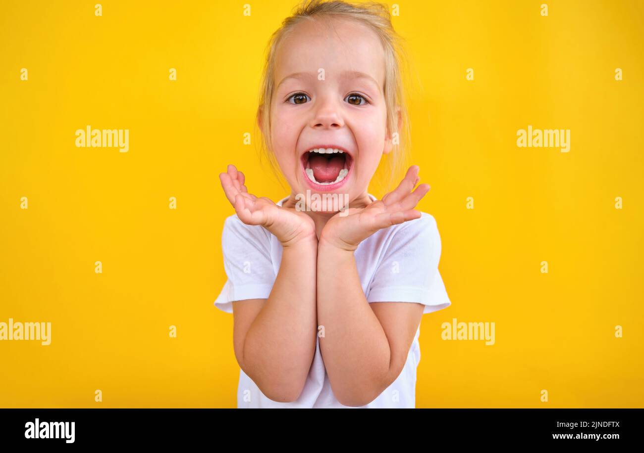 Amazed joyful preschool girl smiling open mouth isolated on yellow ... Amazed joyful preschool girl smiling open mouth isolated on yellow ...