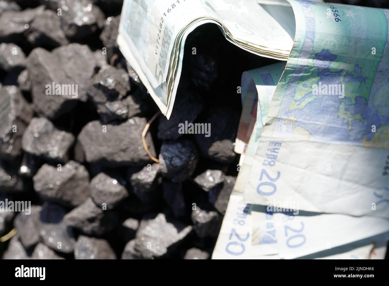a pile of coal on which the money is lying Stock Photo - Alamy