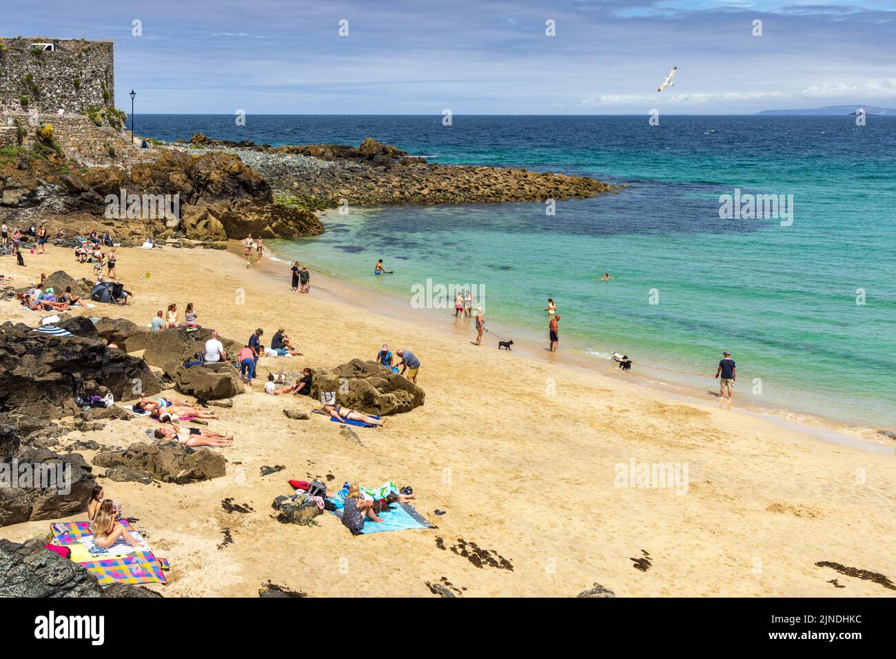 People enjoying a sunny summer's day at Bamaluz Beach in St Ives ...