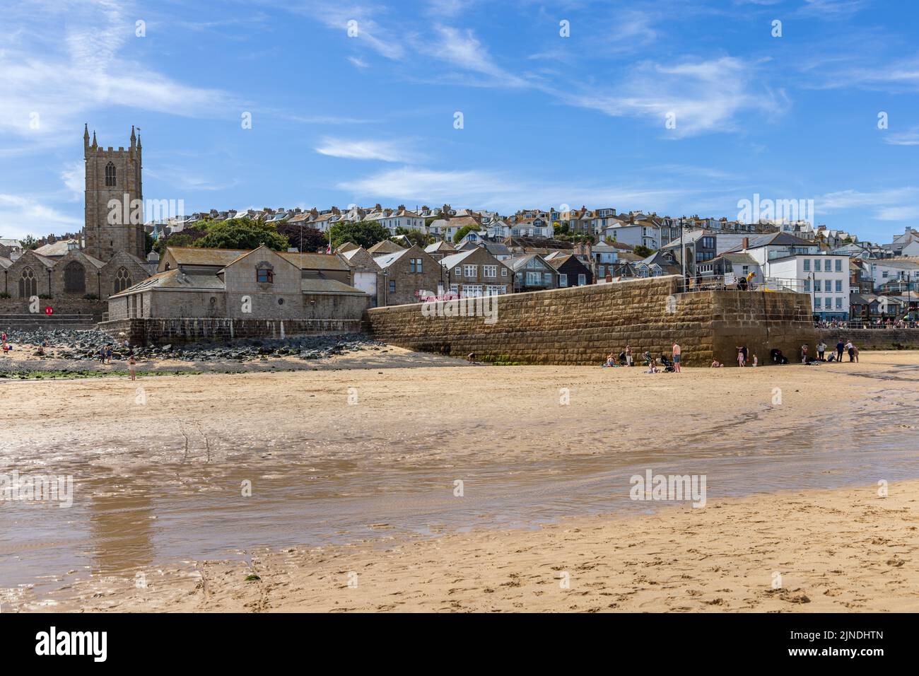 A view of St Ives from the beach, with the pier on the right and St ...