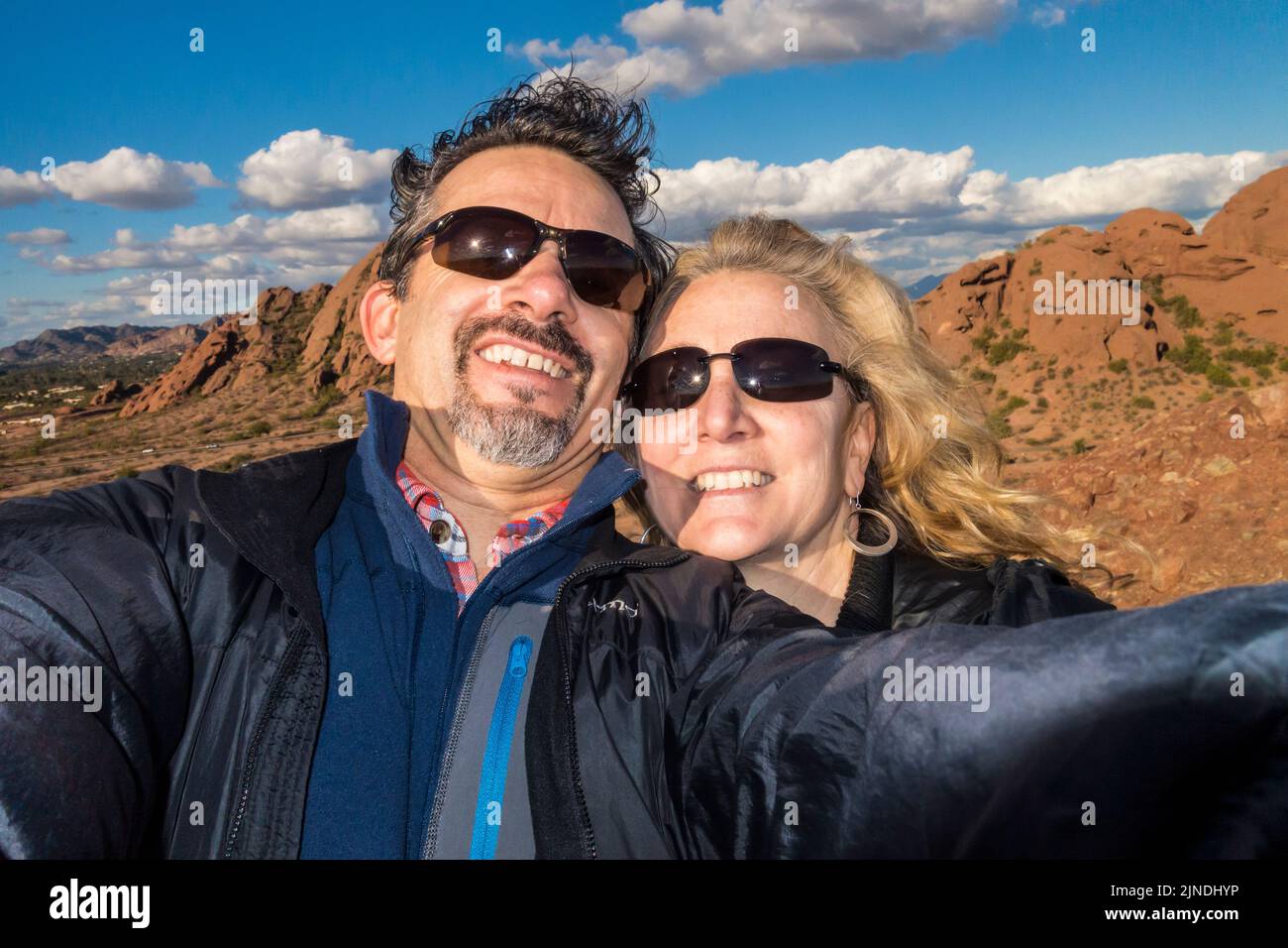 A selfie picture of a middle aged Caucasian couple atop some rocks in ...