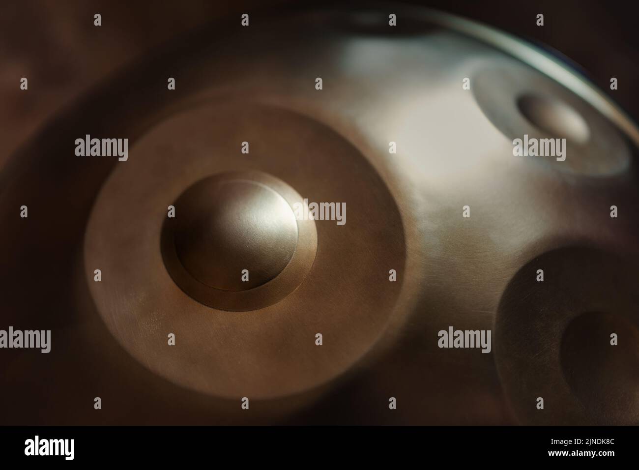 A close-up view of a musical instrument called a handpan, also known as ...