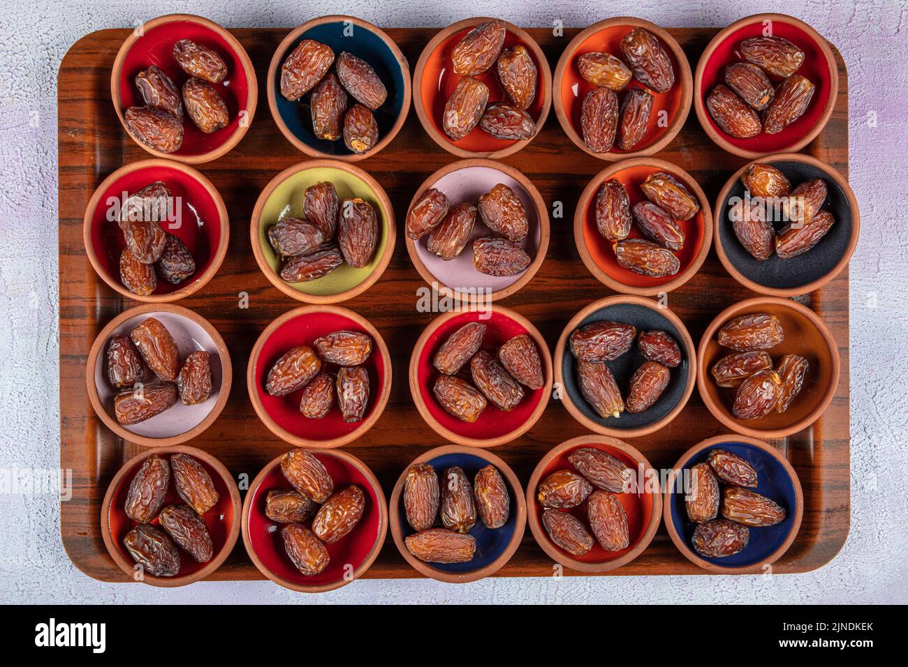 A fresh date-palm and dry date-palm on a wooden trays. Treats of dates ...