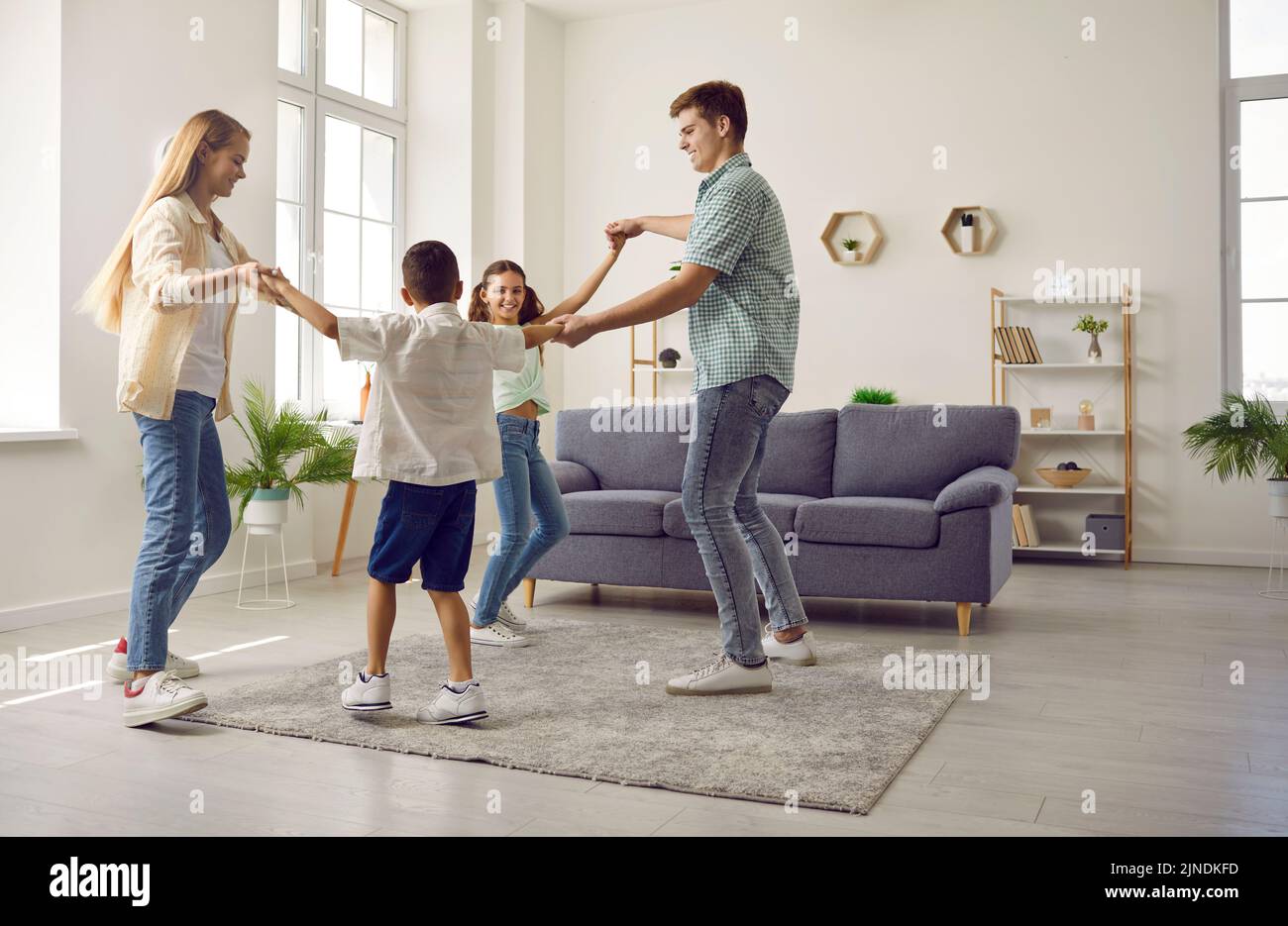 Cheerful young family with two children spend time together playing at ...