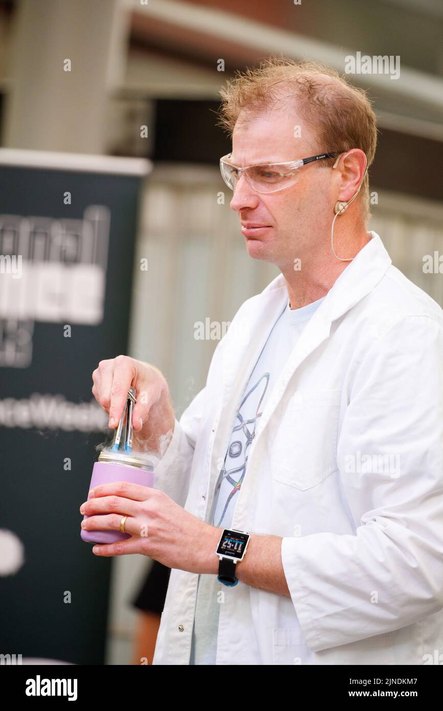 Dr Rob Bell performs live experiments to an audience of school students ...