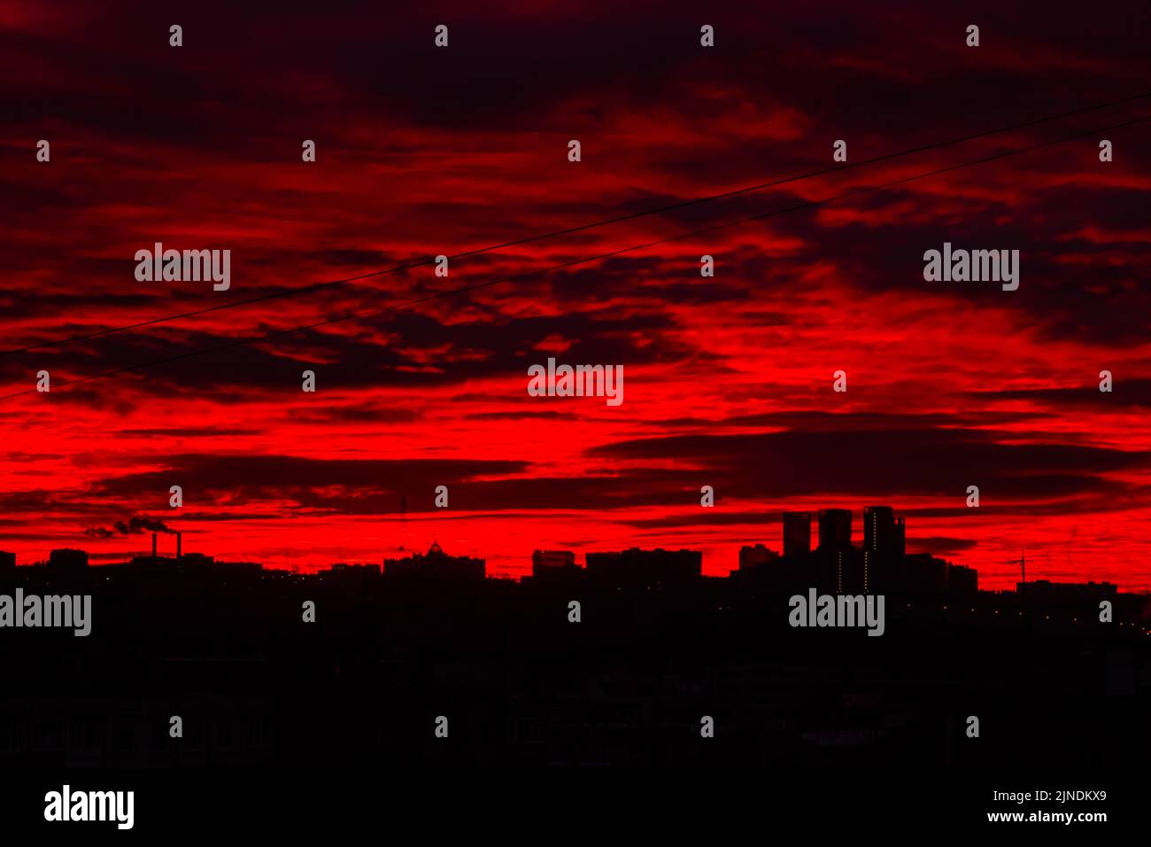 Colorful red sunrise over city and dramatic sky with clouds Stock Photo ...