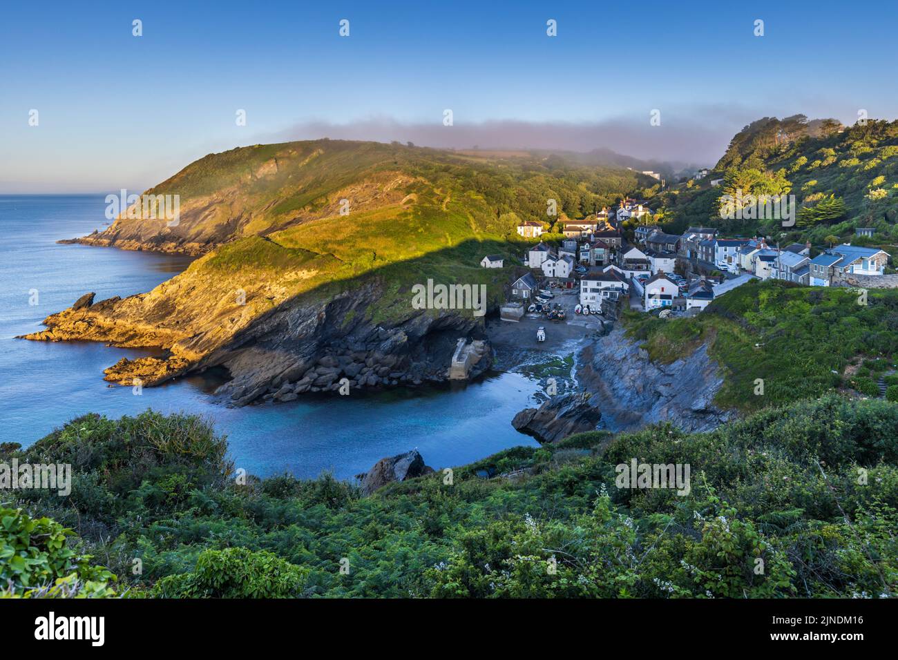 View down to the picturesque fishing village of Portloe on the south ...