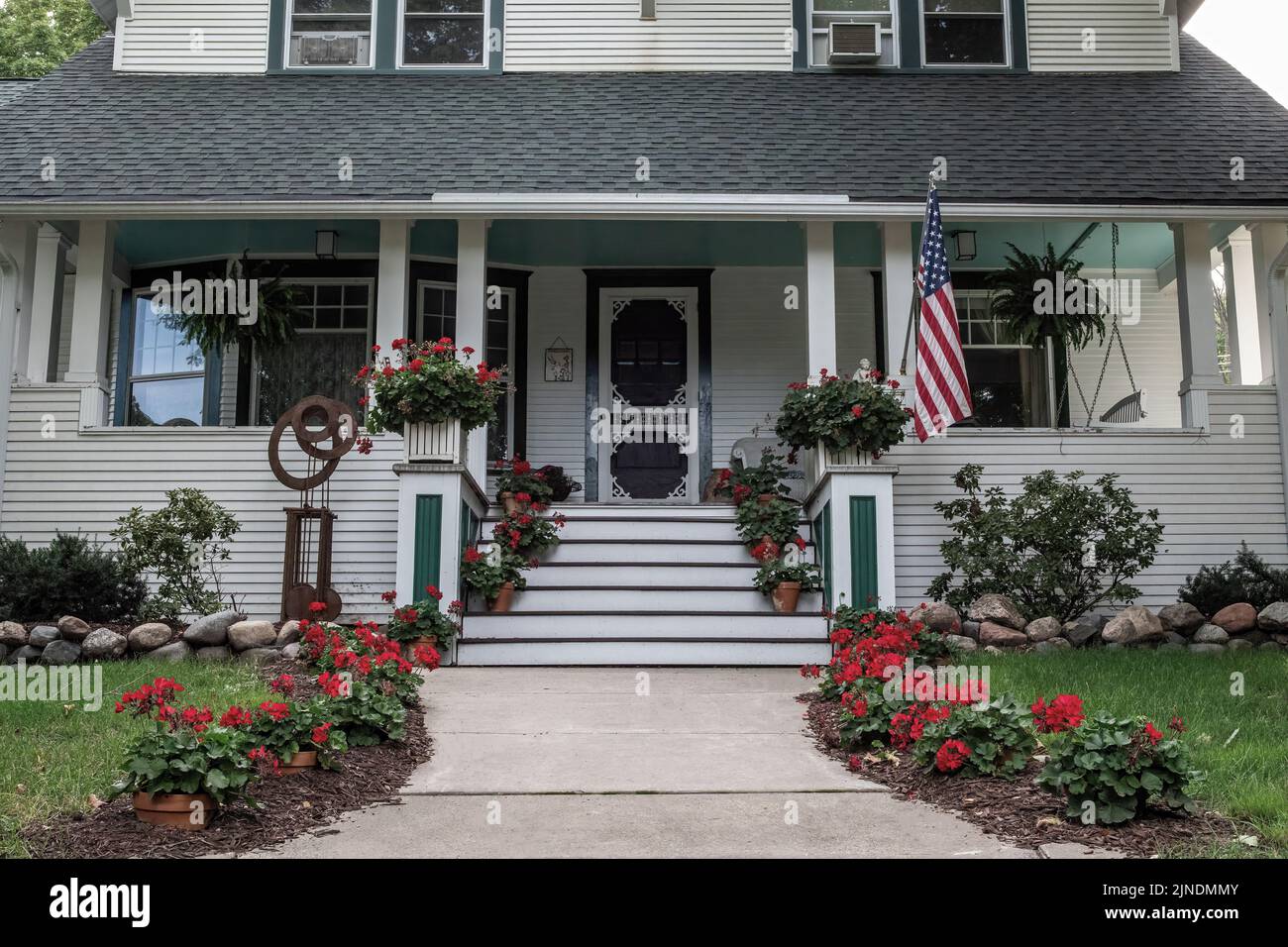 Beautiful white house with a front porch and sidewalk decorated with ...