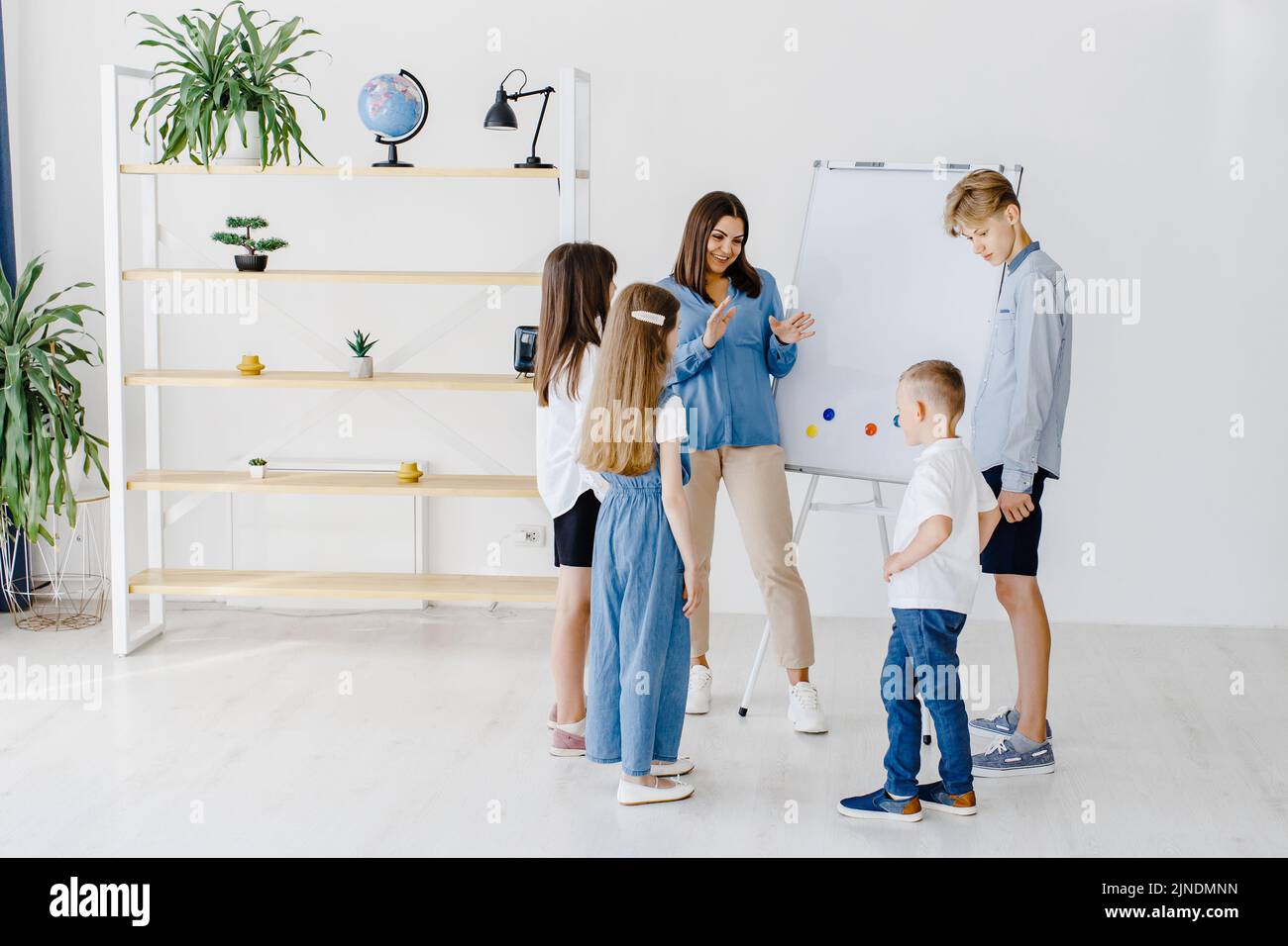 Explaining lesson and using board. Group of children students of ...