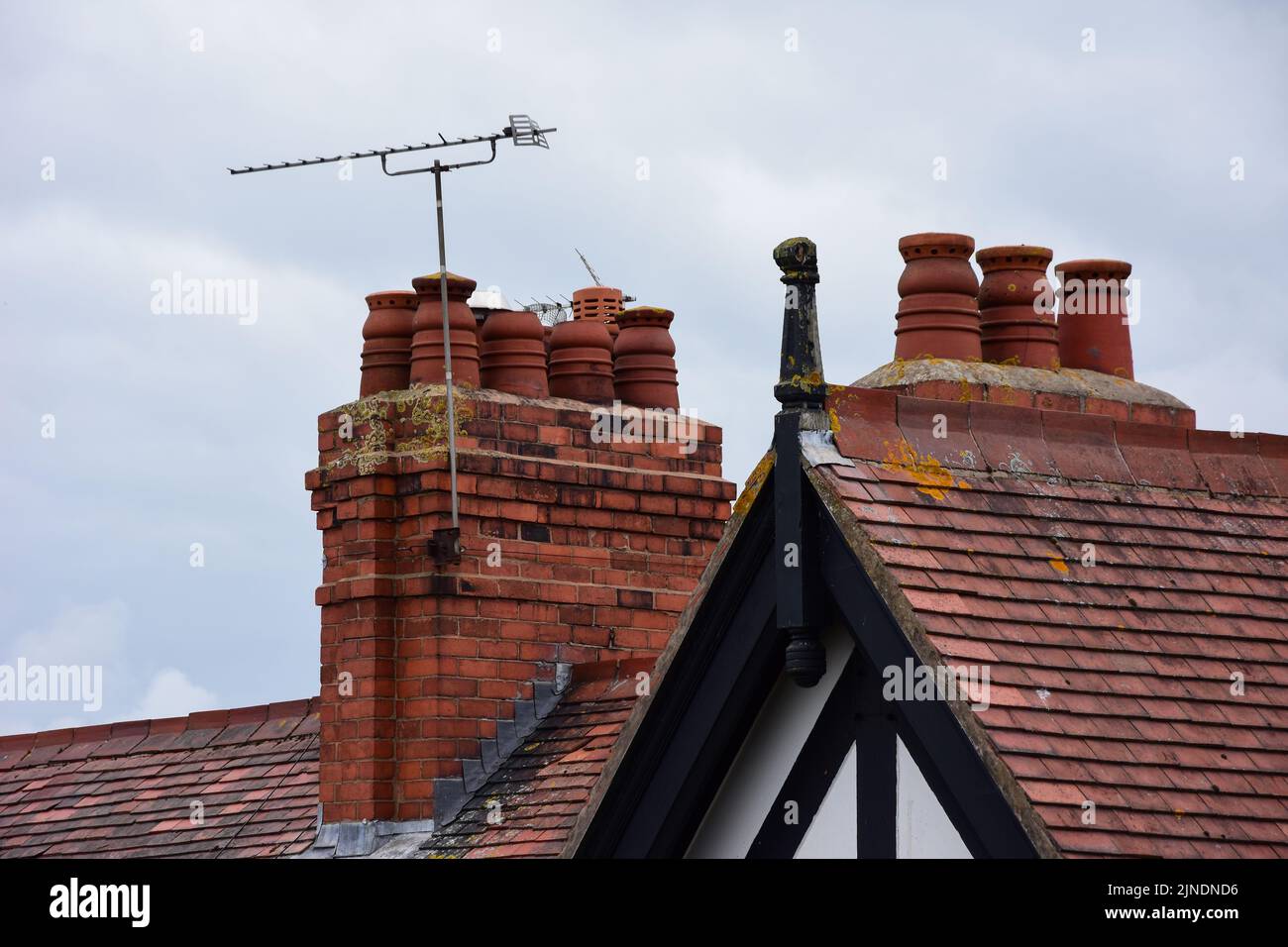 Clay chimney pots on the top of red brick chimney stack of a ...