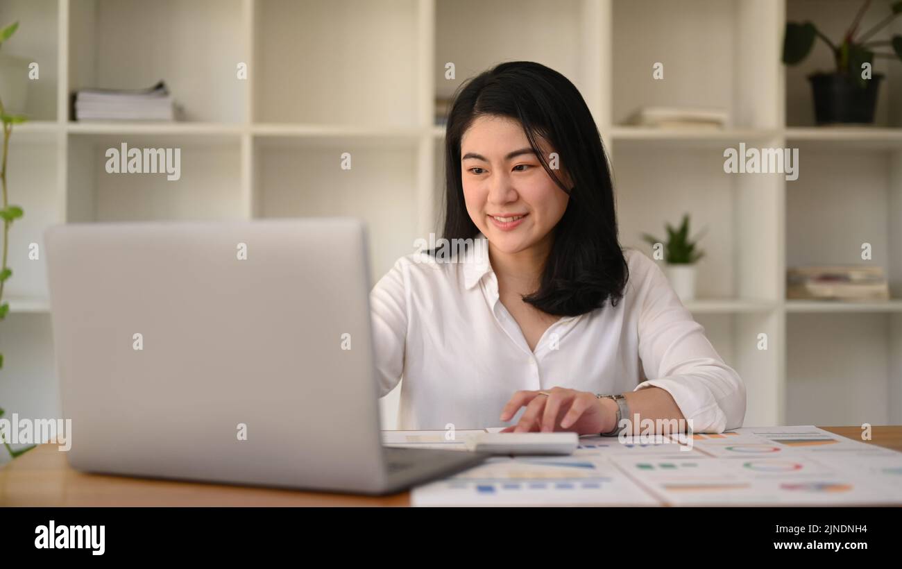 Asian businesswoman working with laptop computer and preparing annual ...