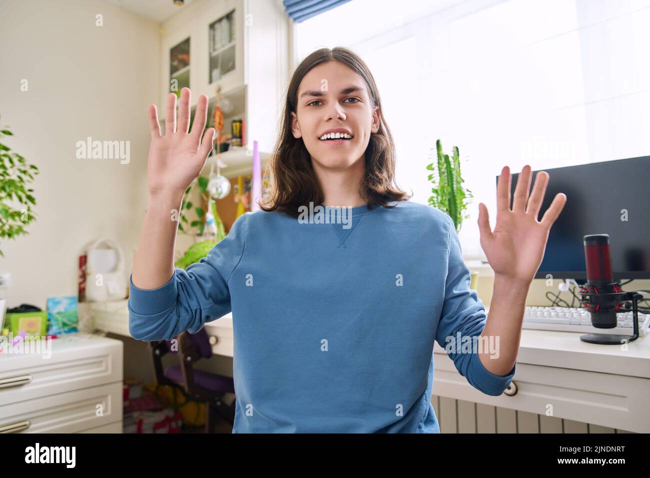 Teenage male student talking looking at web camera Stock Photo - Alamy