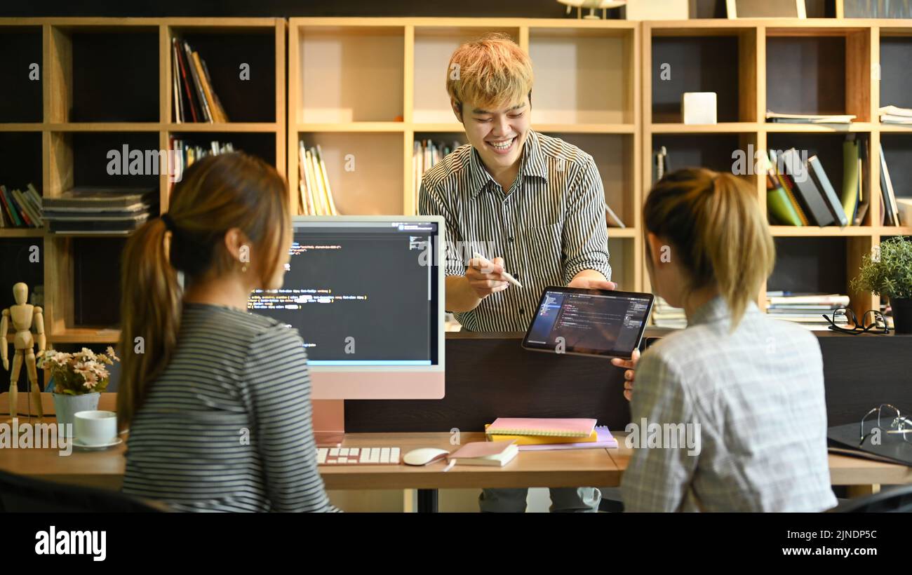 Team of young specialist creating innovative software, working together ...