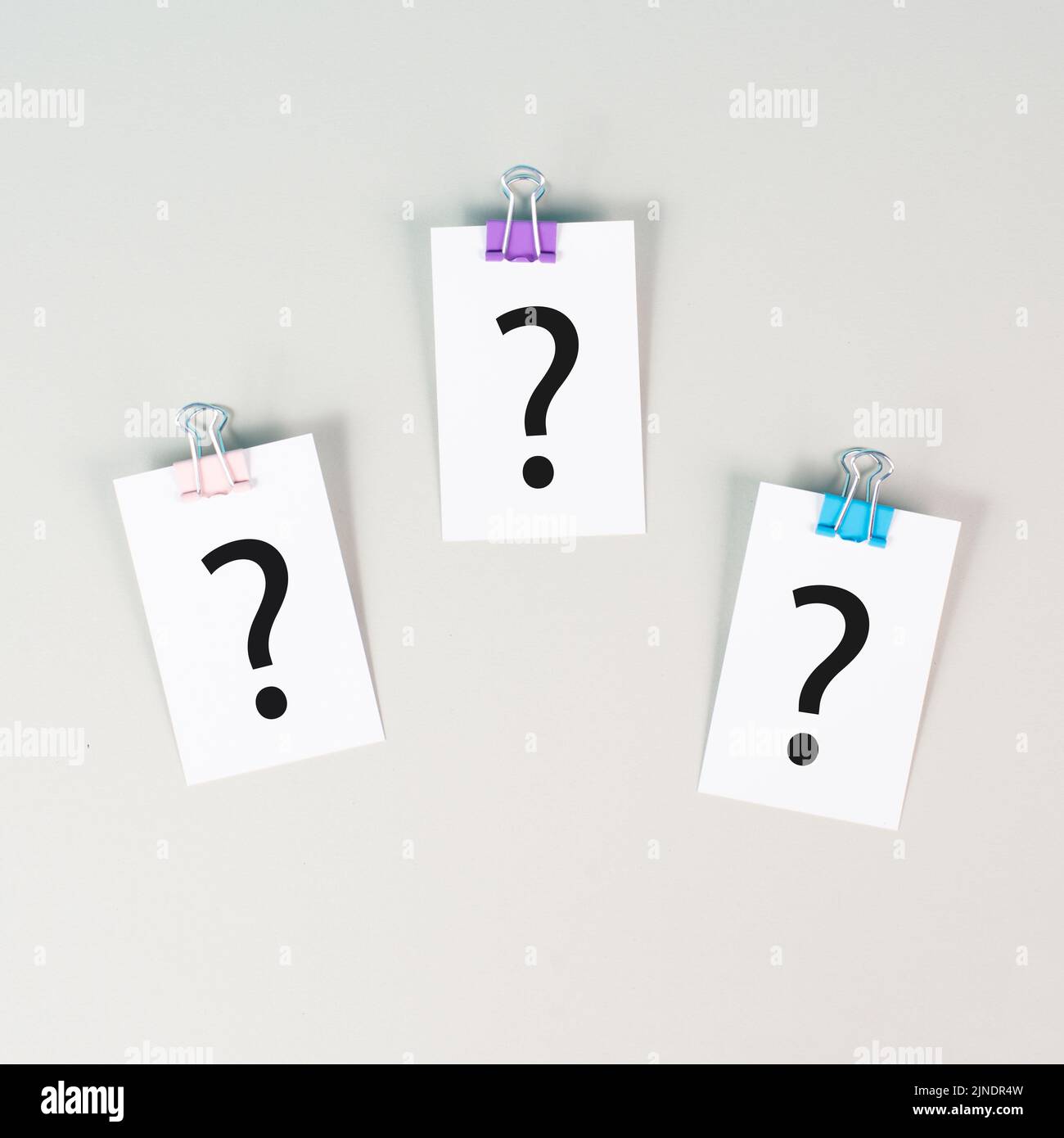 Question marks on paper, brainstorming and looking for answers, solving ...