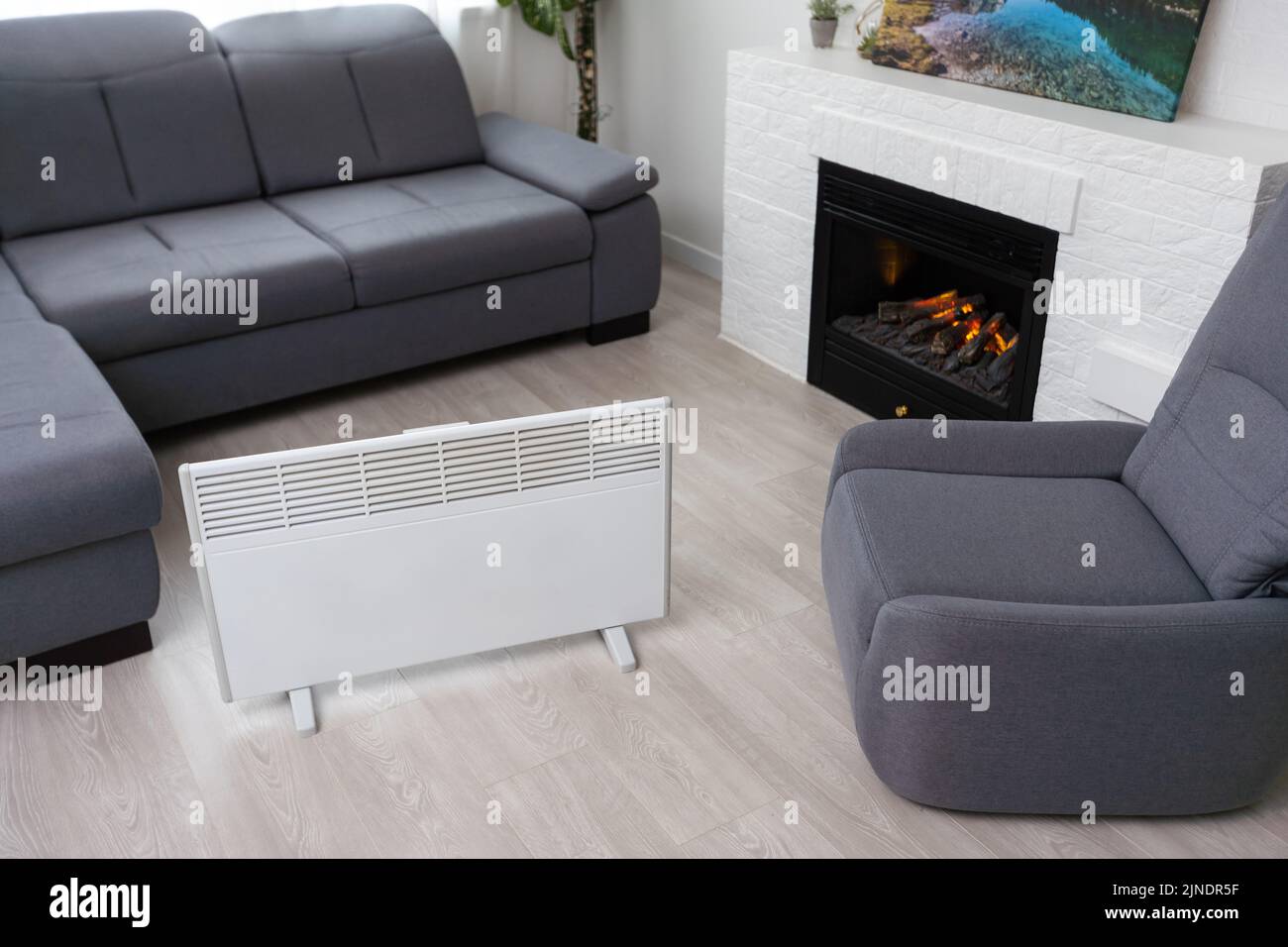 Modern electric heater in stylish room interior Stock Photo - Alamy