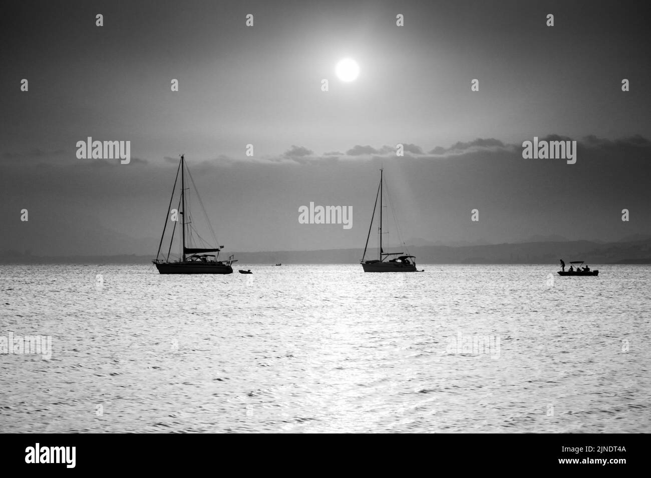 two boats and a boat in the middle of the sea Stock Photo - Alamy