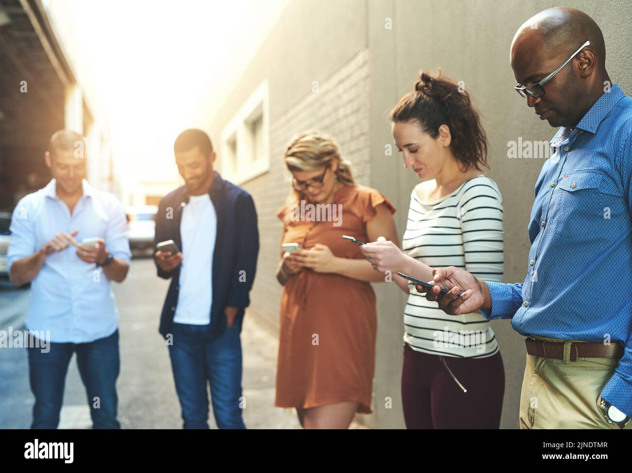 Diverse group of adult people connecting and social networking outside ...