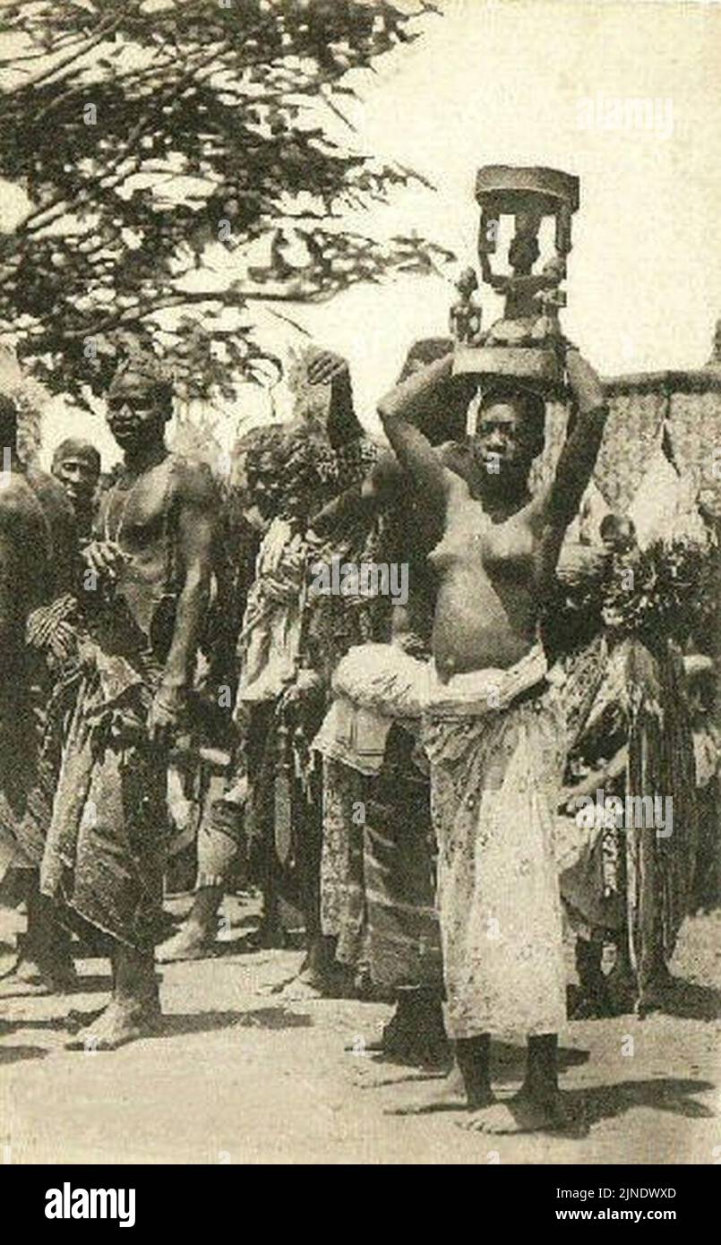 The celebration at Abomey. - Young girl with wooden statue of mystic ...