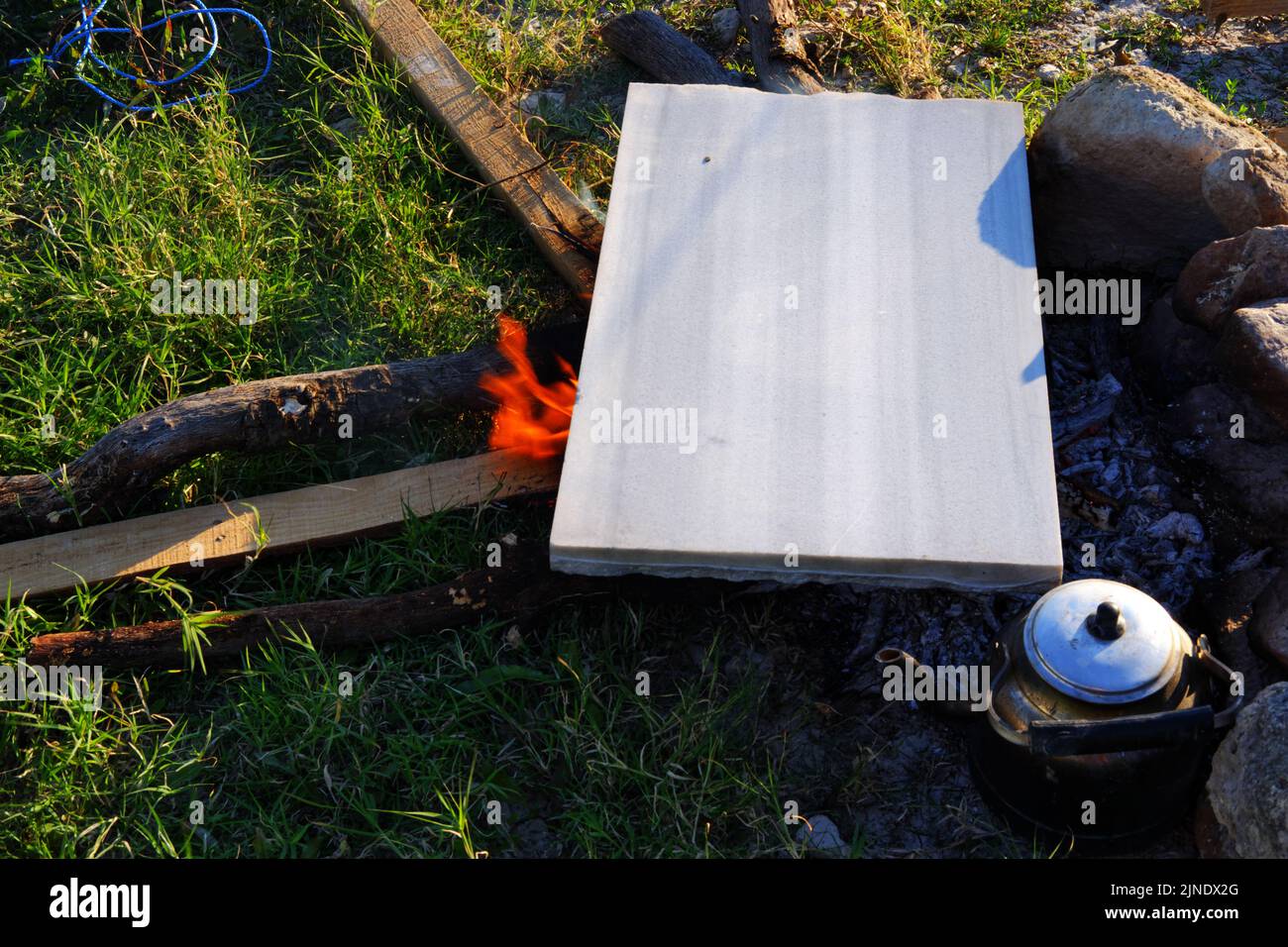 Marble on camp fire for cooking and teapot by the fire outdoor Stock ...