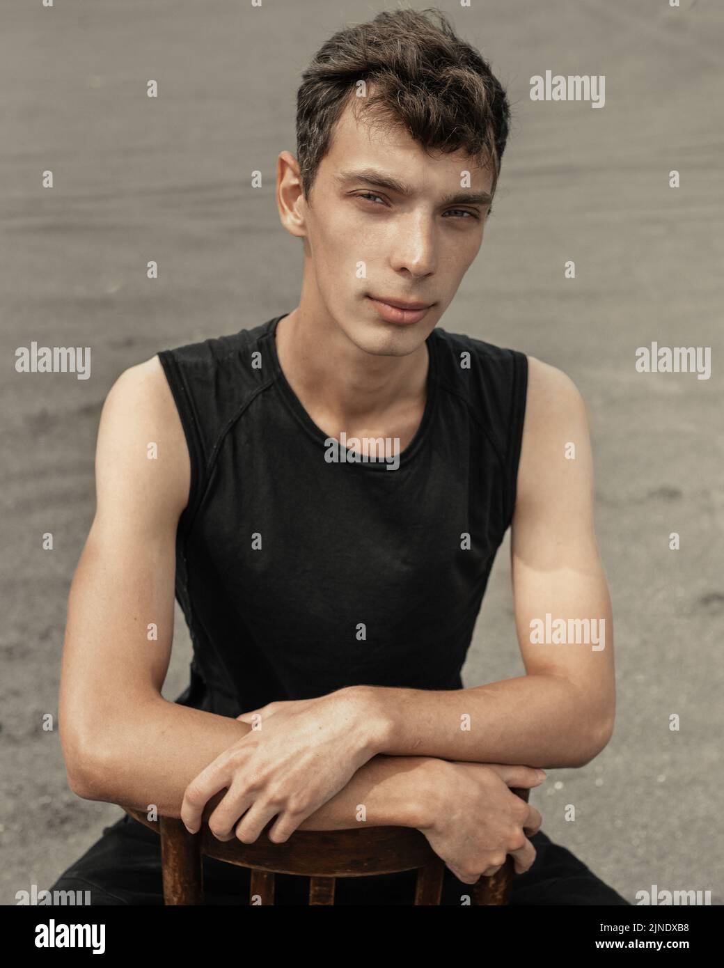 Portrait of Man sitting on chair in desert Stock Photo - Alamy