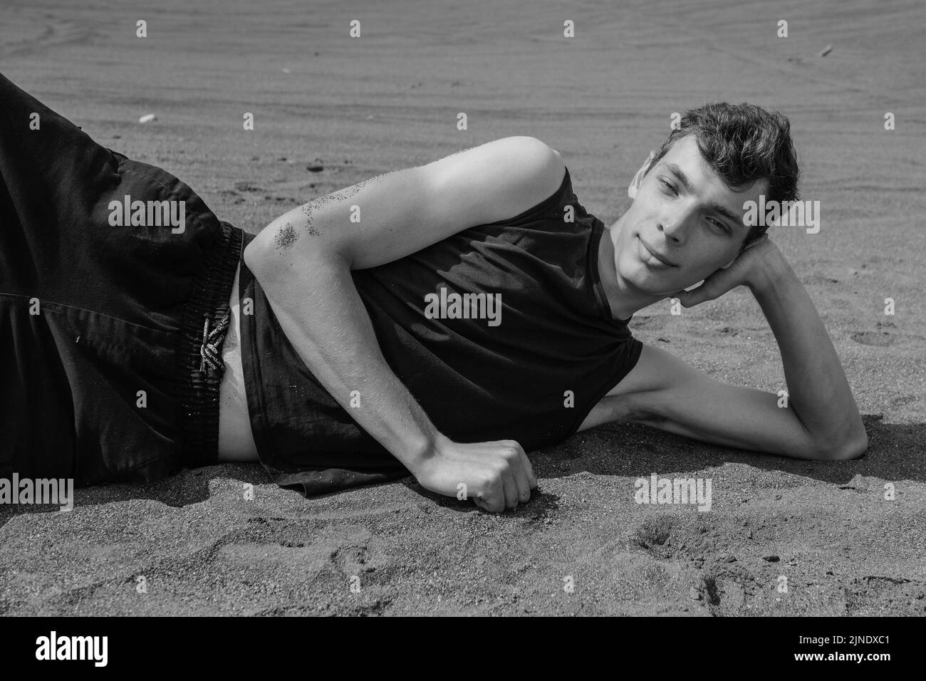 Lone Man lying on sand in desert Stock Photo - Alamy