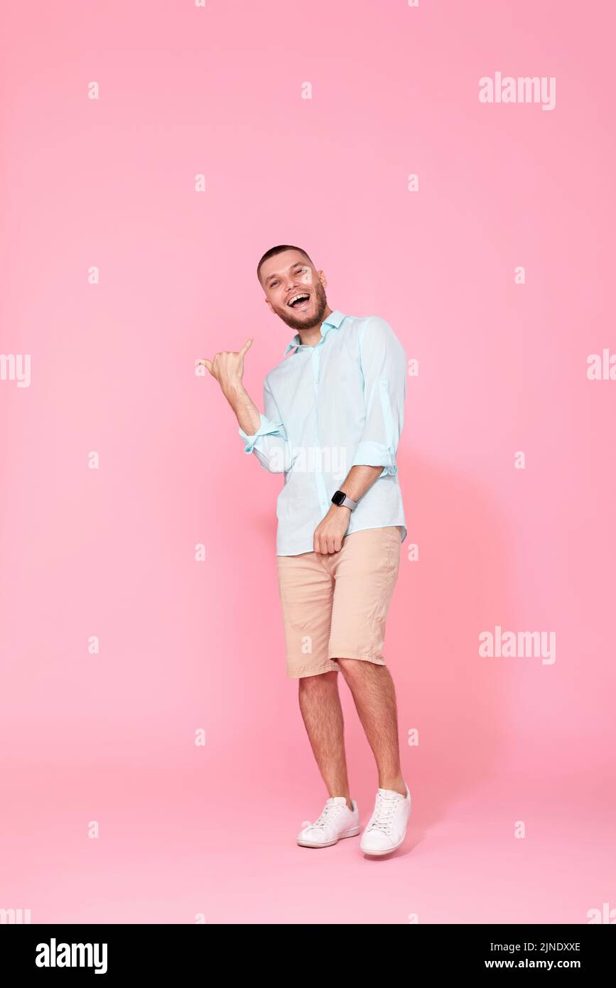 cheerful young happy man dance on pink background Stock Photo - Alamy