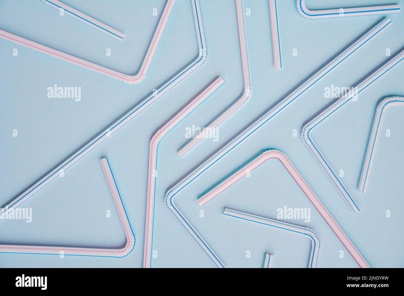 Plastic straws on a blue background Stock Photo - Alamy