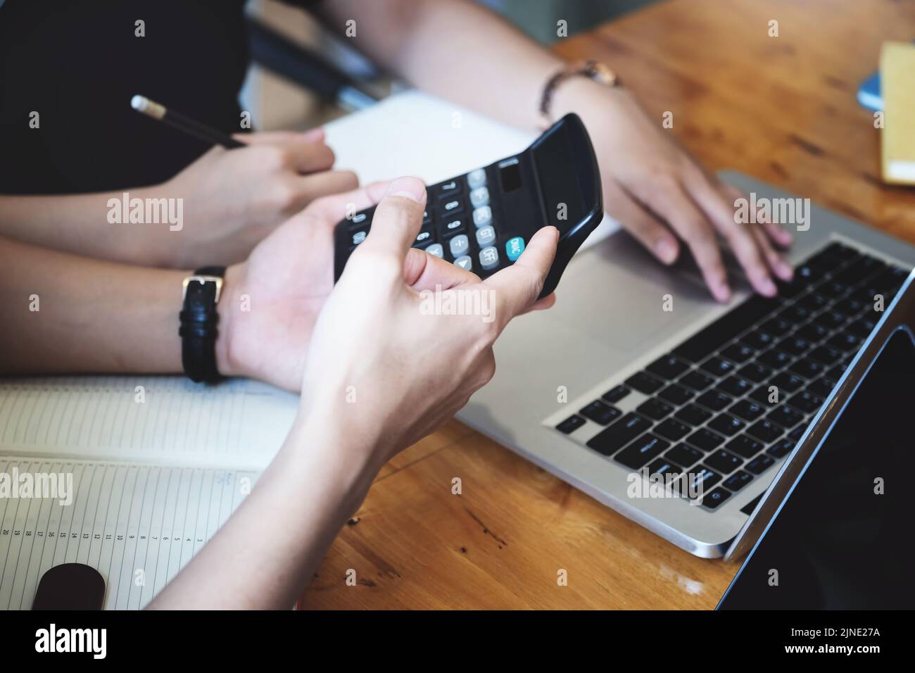 vintage tone effect with business man using calculator to calculate ...