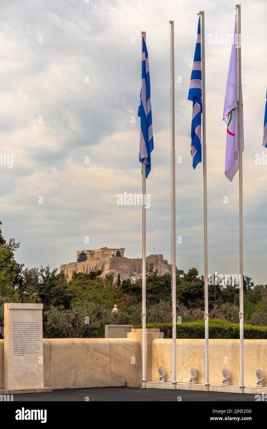 A vertical shot of flags with the Acropolis of Athens in the background ...