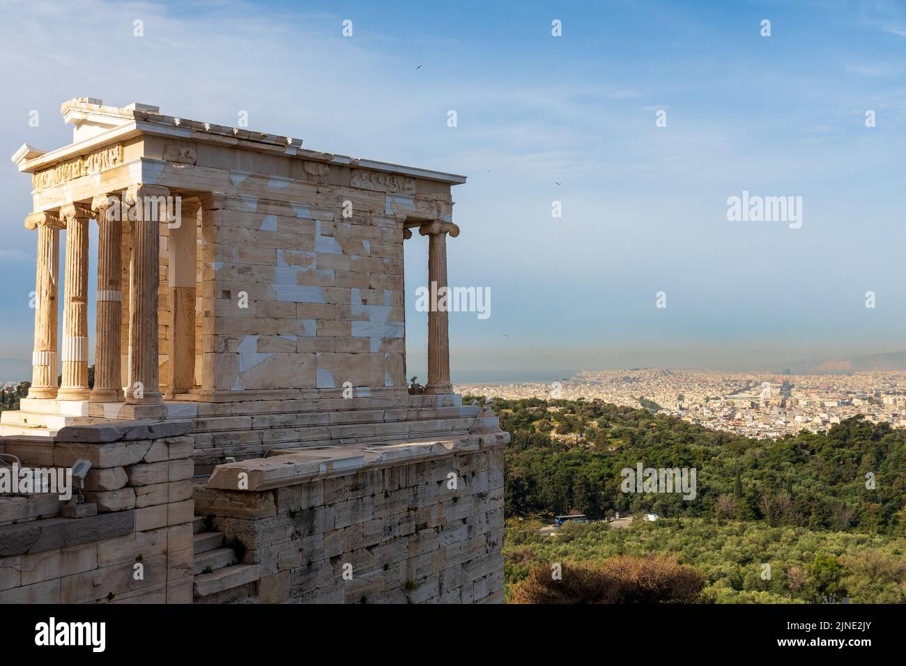 A scenic view of the Acropolis of Athens, Greece with forests in the ...