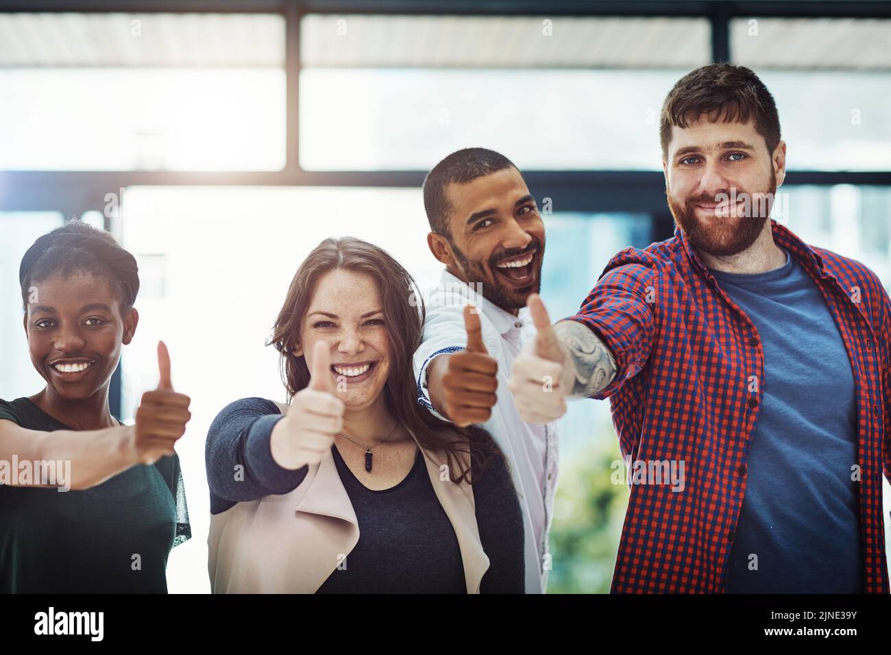 Teamwork, support and trust with a thumbs up from happy colleagues ...