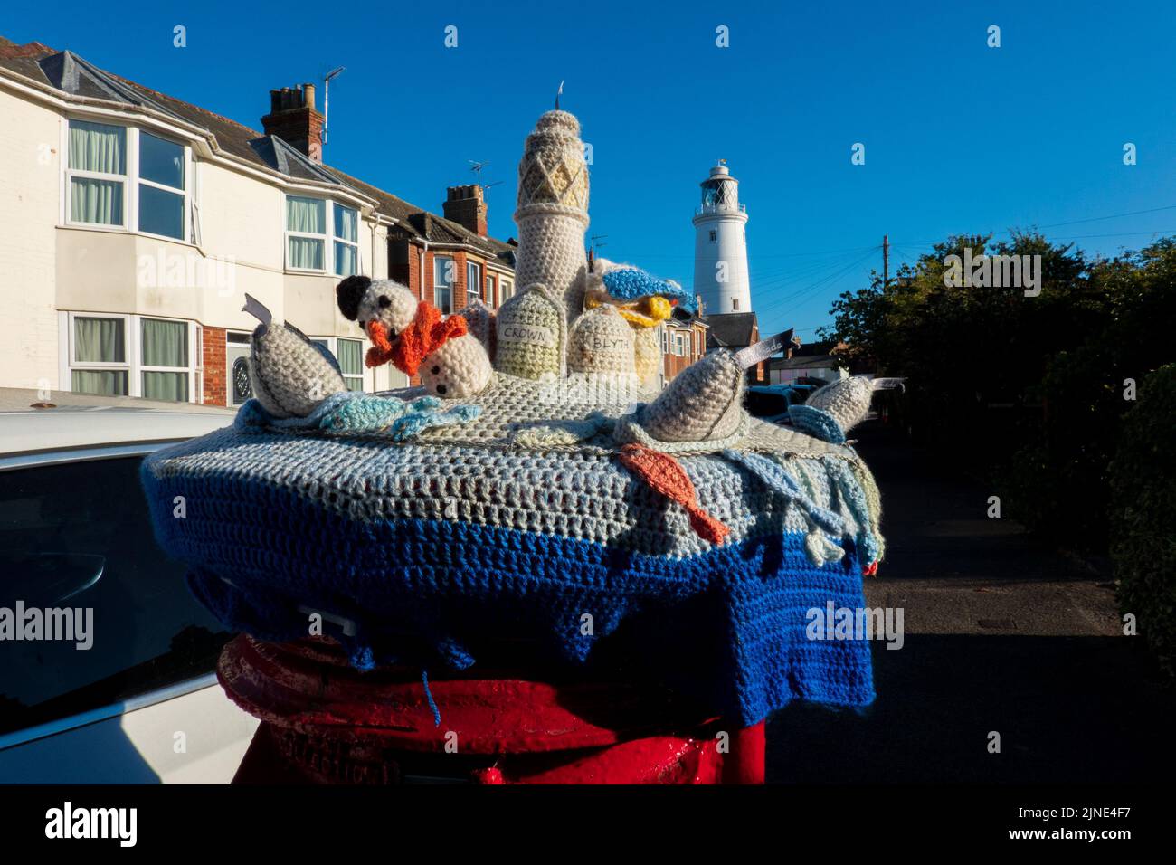 Southwold red post boxes decorated with knitted scenes Stock Photo - Alamy
