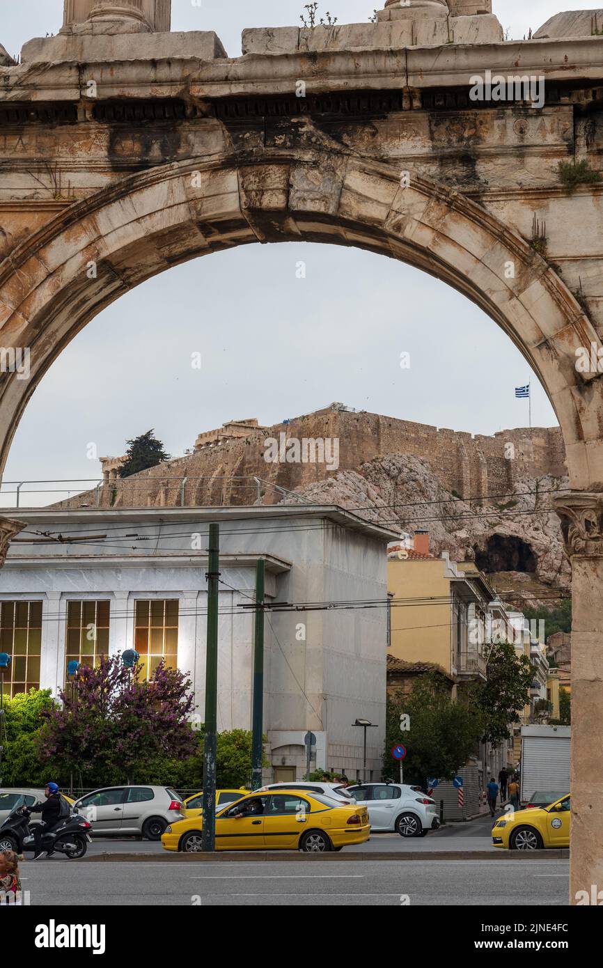 A vertical shot of the Acropolis in the background through Adriano Arch ...