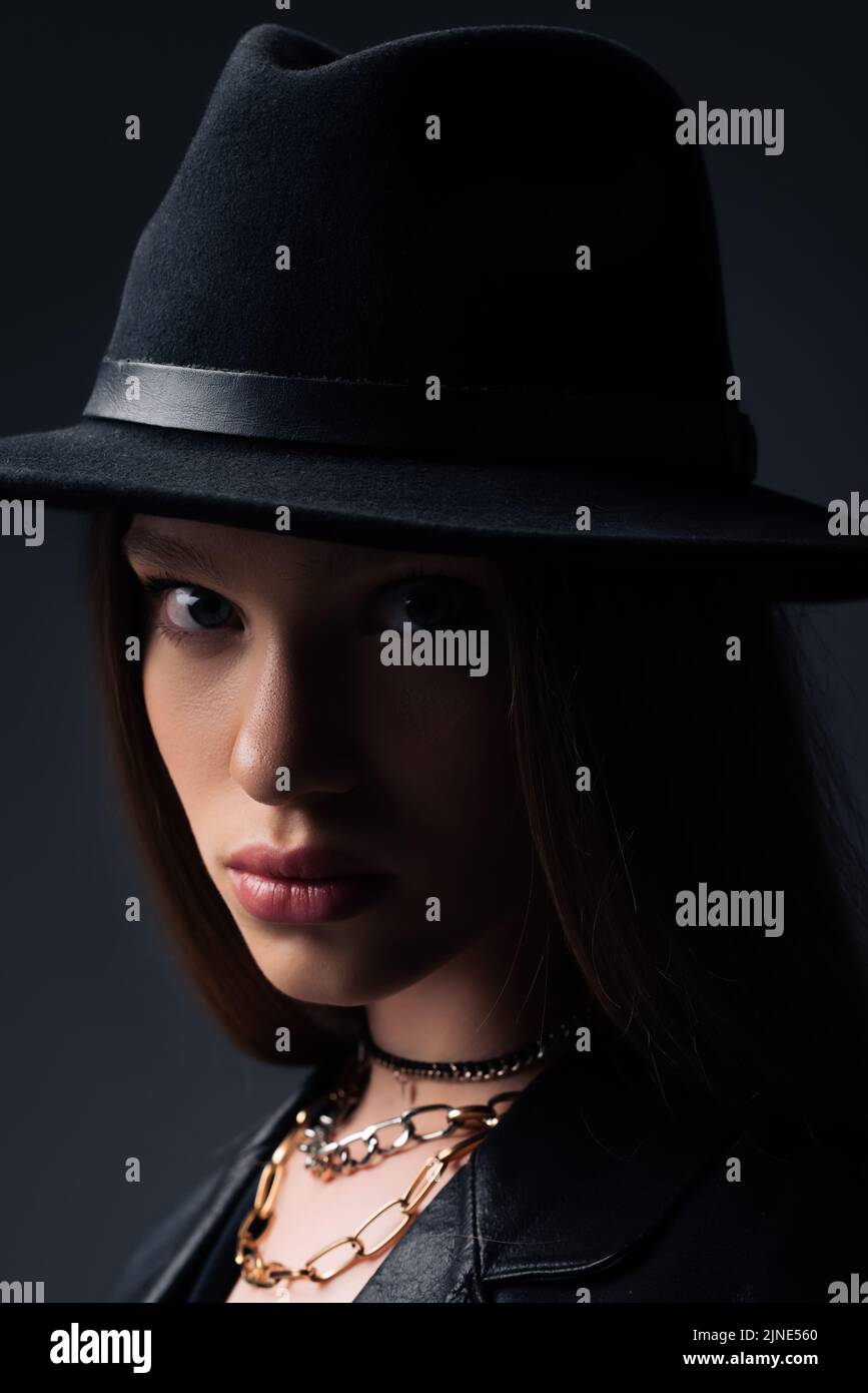 portrait of teenage model in fedora hat looking at camera isolated on ...