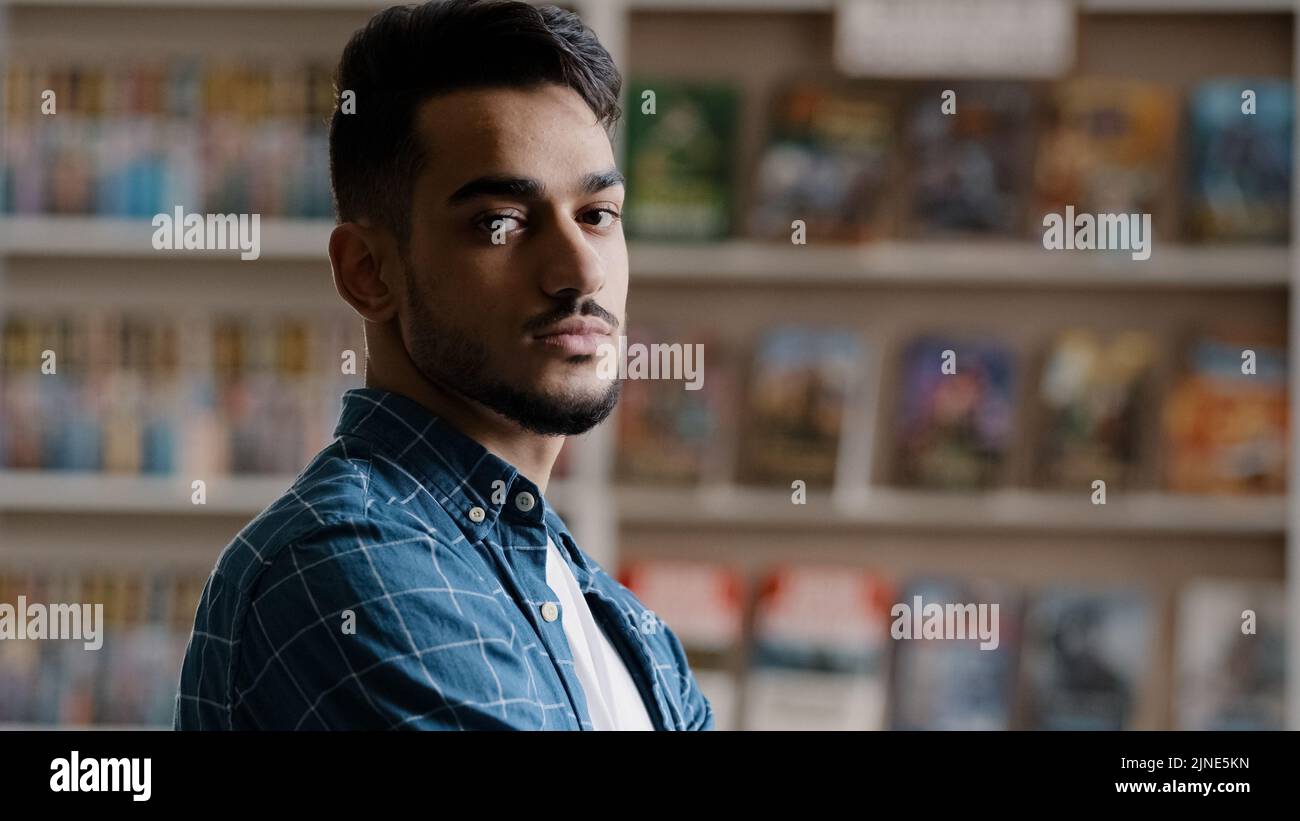 Portrait of young serious arabic model man with beard in plaid shirt ...