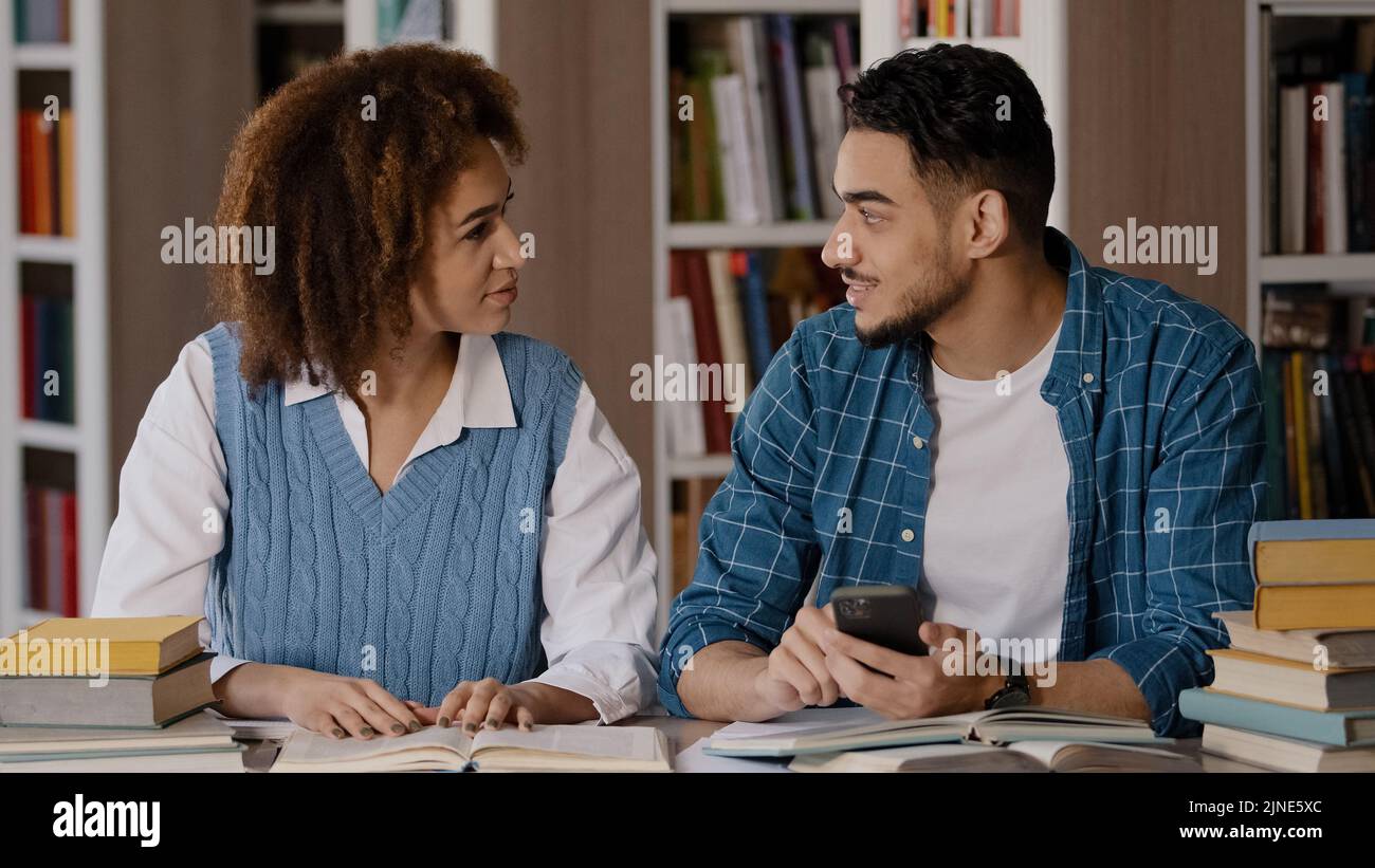 Students do homework in library teamwork working on joint project cute ...