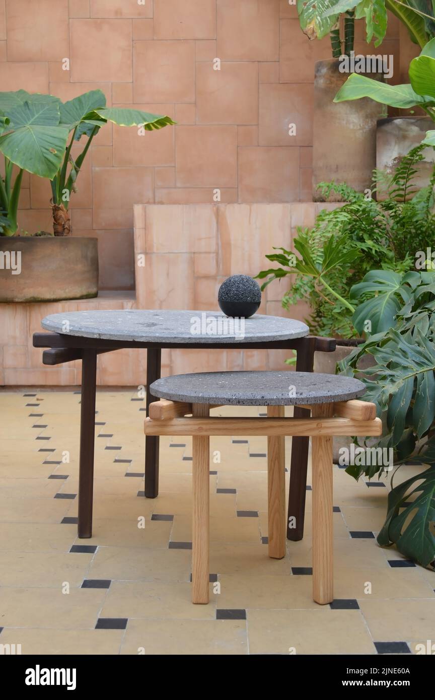 A vertical shot of a modern round coffee table, natural stone, and wood ...