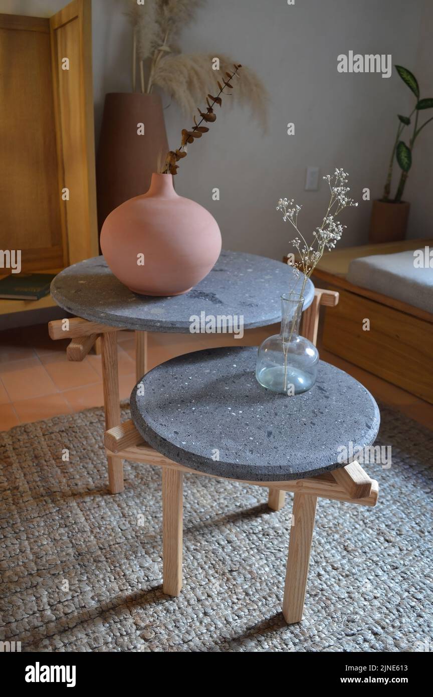 A vertical shot of a modern round coffee table, natural stone, and wood ...