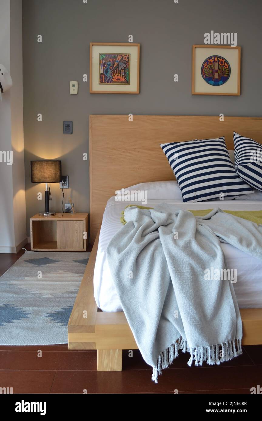 A modern bedroom interior with a double bed, mat on the floor and ...