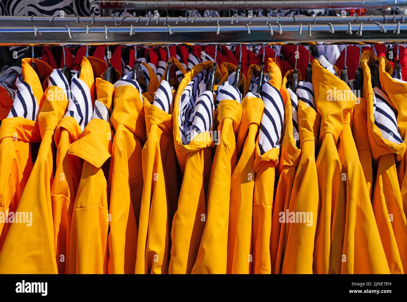 View of traditional yellow raincoats with striped blue and white lining ...