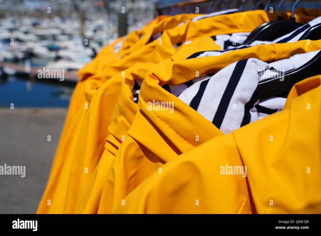 View of traditional yellow raincoats with striped blue and white lining ...