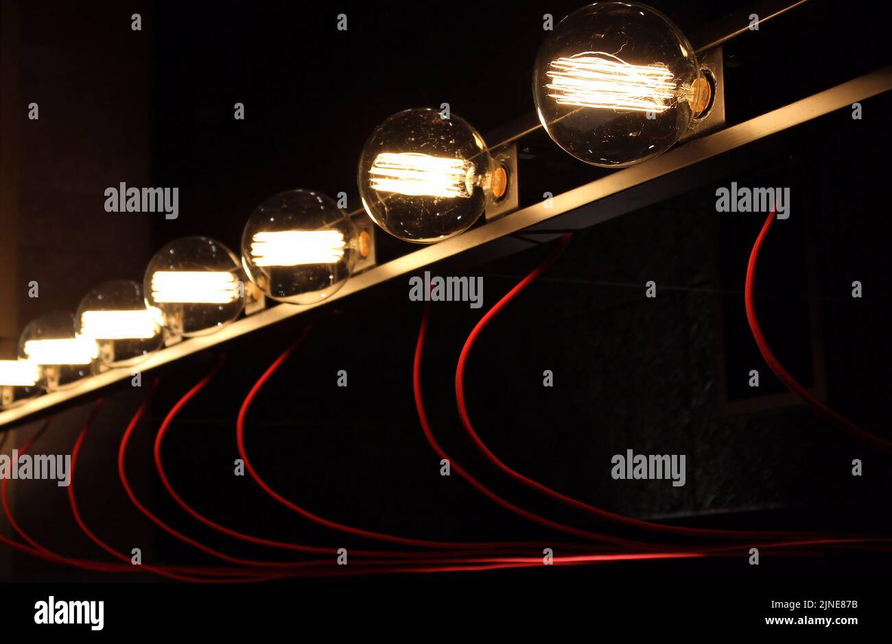 Hot glass of switched electric bulbs in line Stock Photo - Alamy